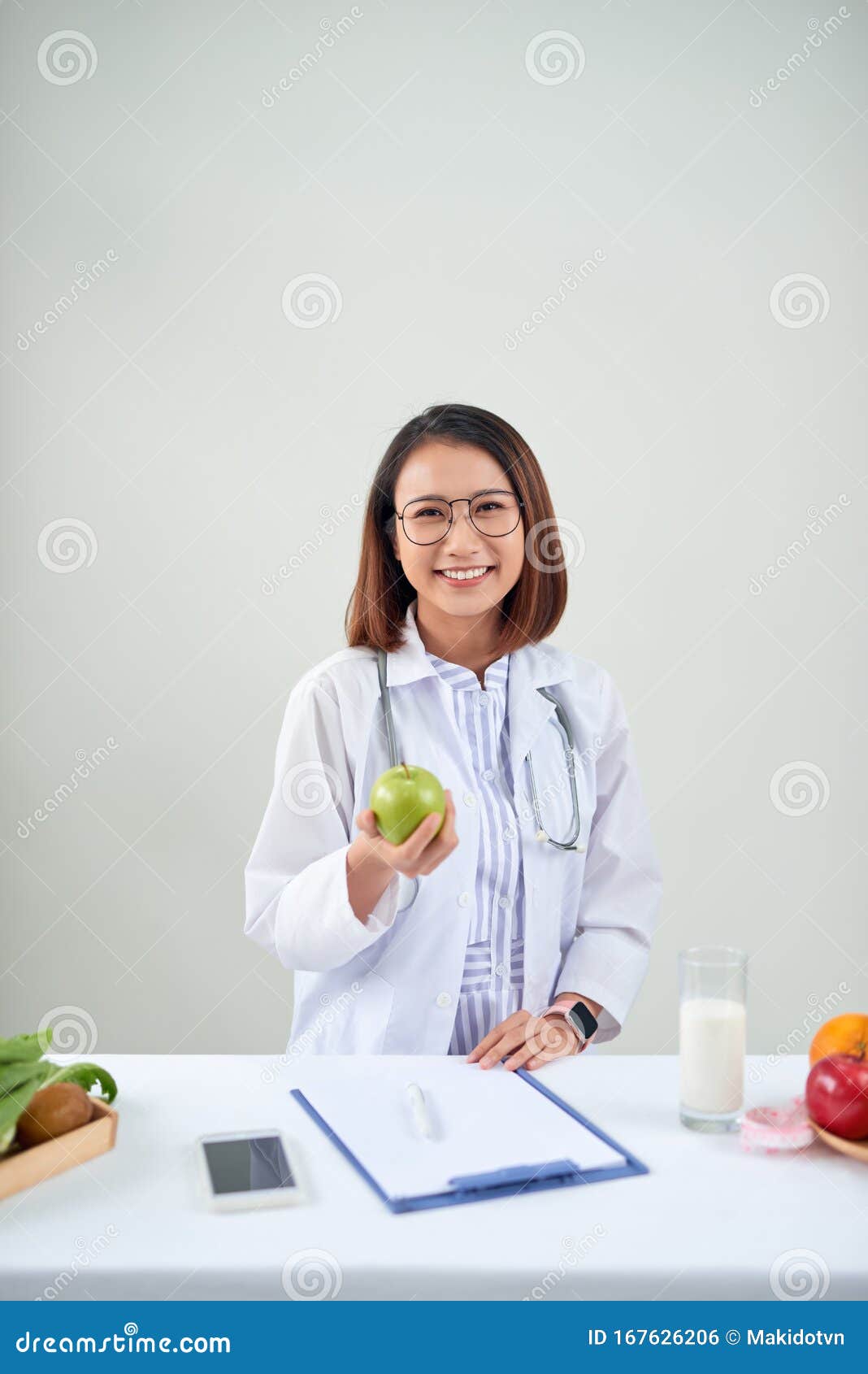 Smiling Nutritionist In Her Office She Is Showing Healthy Vegetables