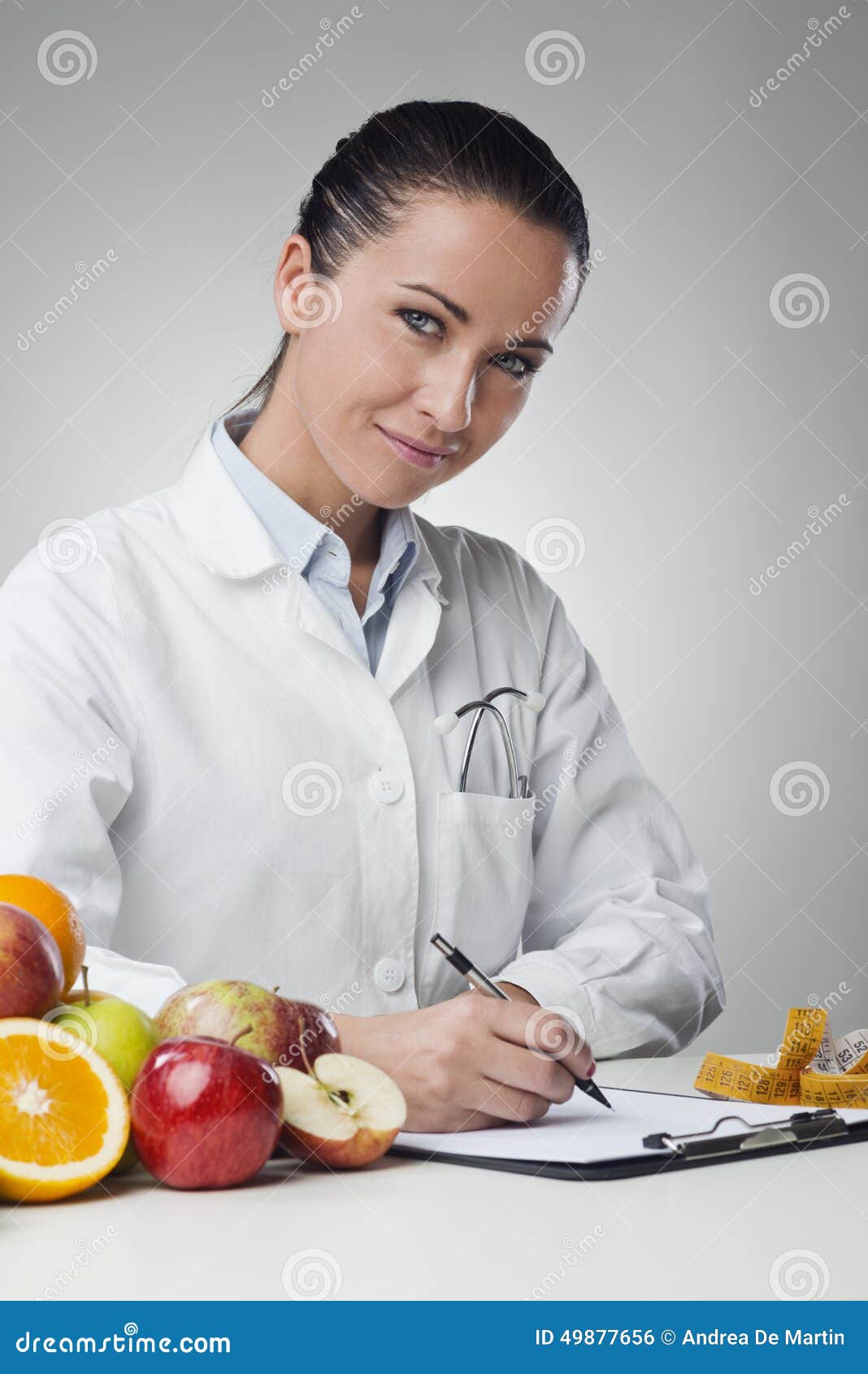 Smiling Nutritionist Writing Medical Records Stock Photo - Image of ...
