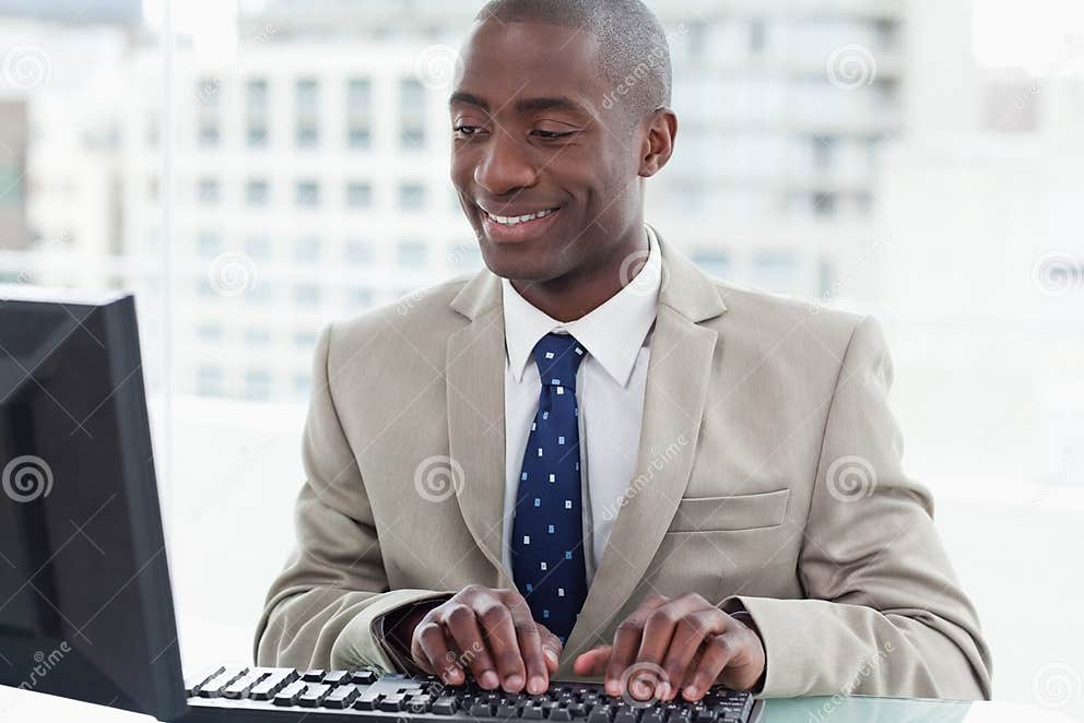Smiling Office Worker Using a Computer Stock Photo - Image of expert ...