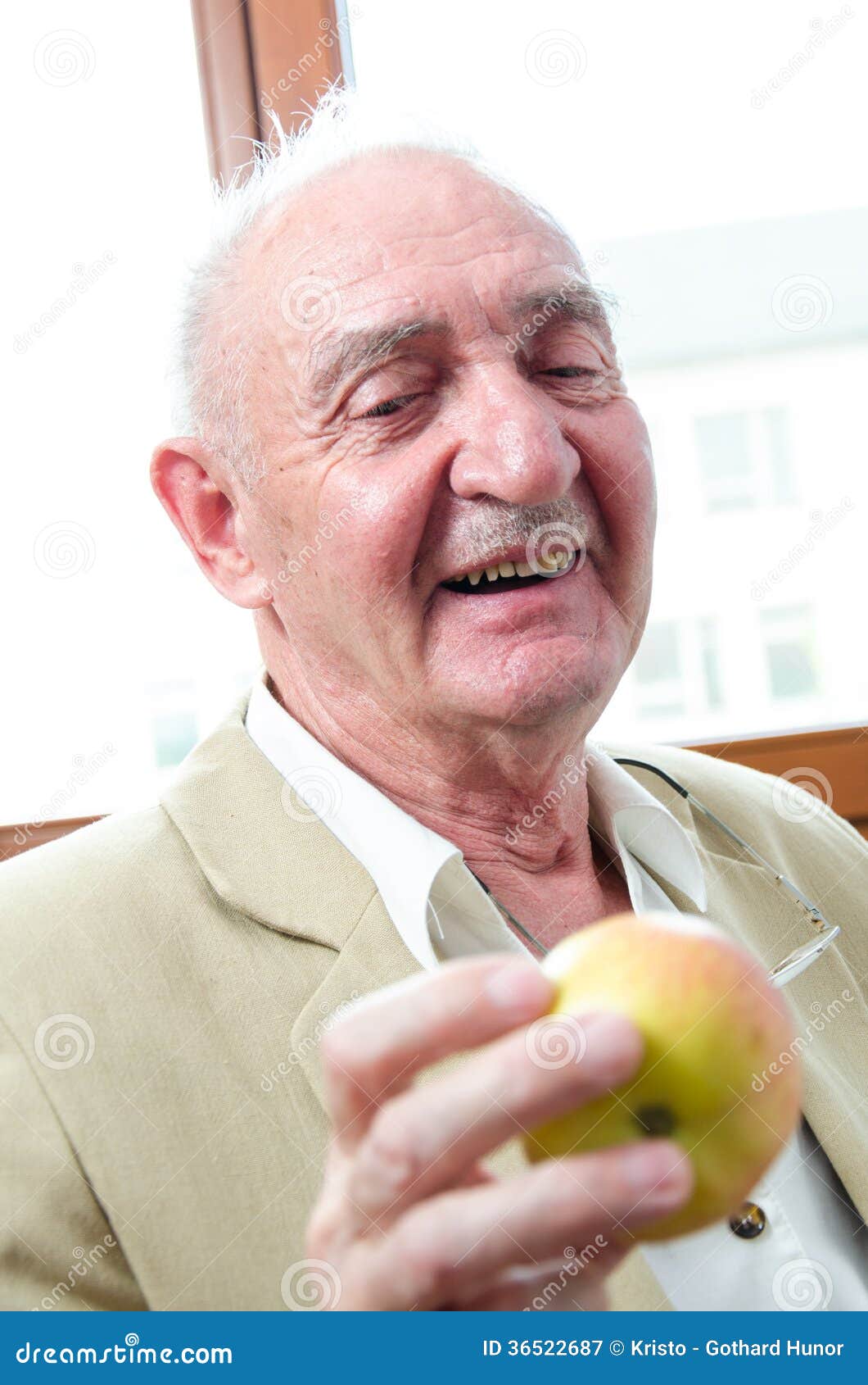 Smiling old man with apple stock image. Image of grandfather - 36522687