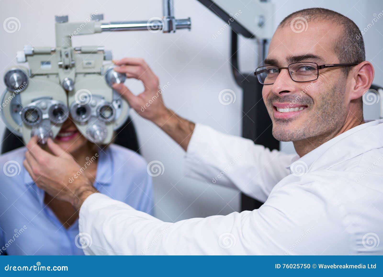 Smiling Optometrist Examining Female Patient on Phoropter Stock Photo ... Smiling Optometrist Examining Female Patient on Phoropter Stock Photo ...