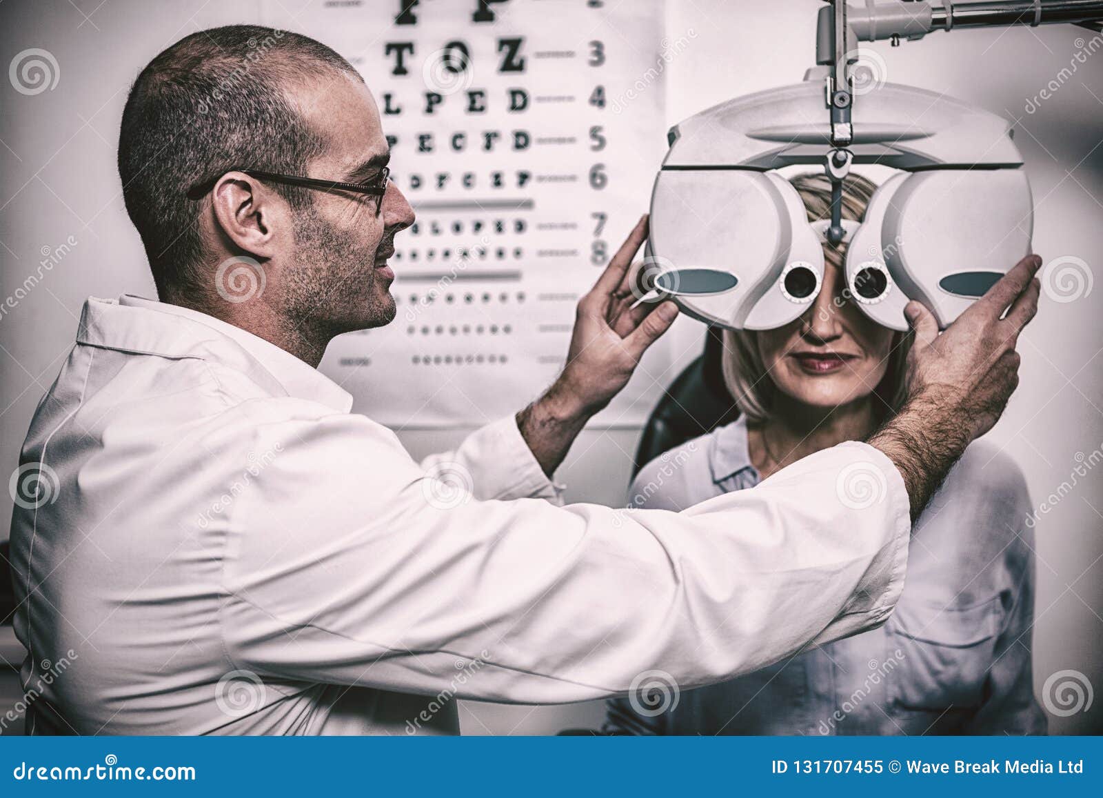 Smiling Optometrist Examining Female Patient on Phoropter Stock Image ... Smiling Optometrist Examining Female Patient on Phoropter Stock Image ...