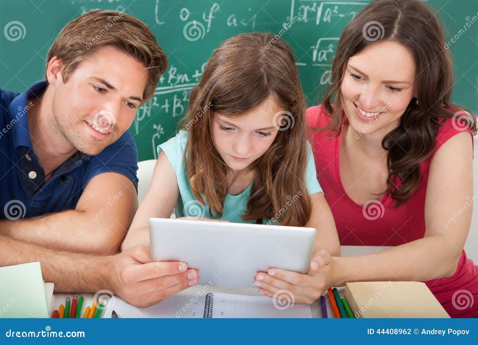 Smiling Parents Assisting Daughter in Using Digital Tablet Stock Photo ... Smiling Parents Assisting Daughter in Using Digital Tablet Stock Photo ...