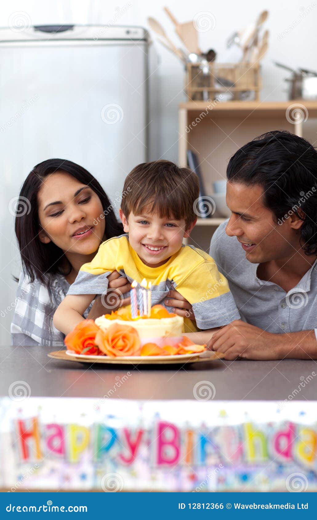 Smiling Parents Celebrating Their Son S Birthday Stock Photo - Image of ...
