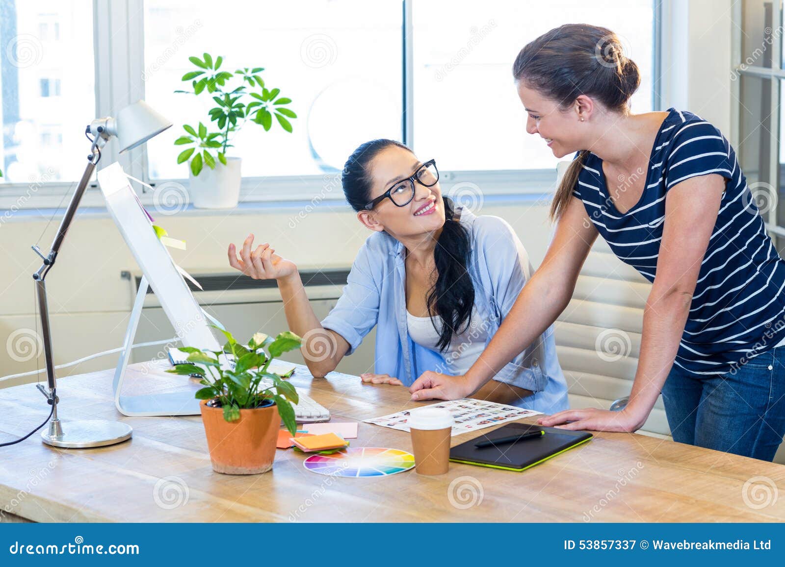 Smiling Partners Discussing Together about Photographs Stock Image ...