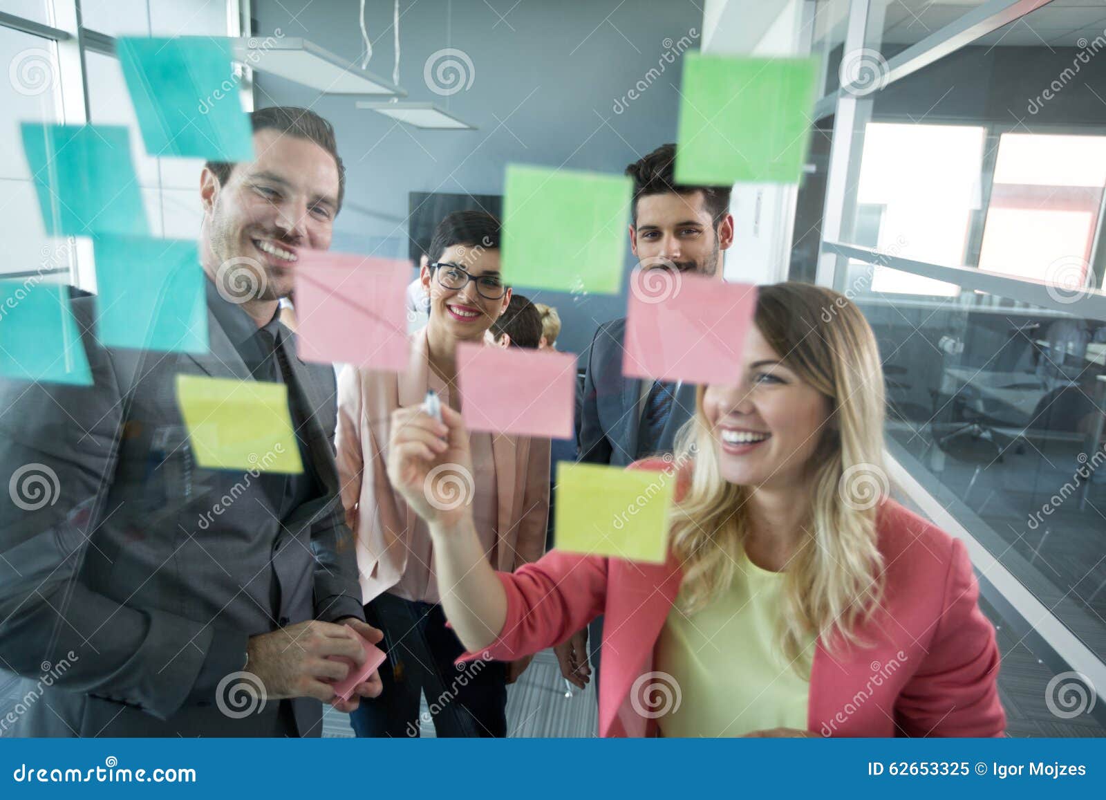 Smiling Partners Looking at Sticky Notes Stock Image - Image of partner ...