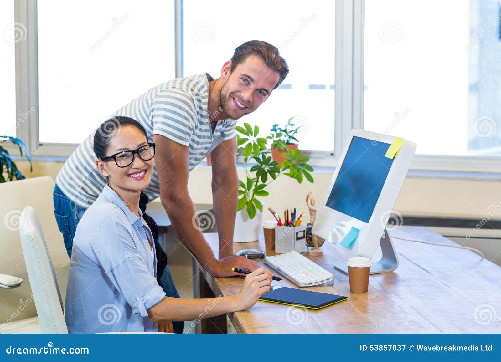 Smiling Partners Working Together on Computer Stock Image - Image of ...