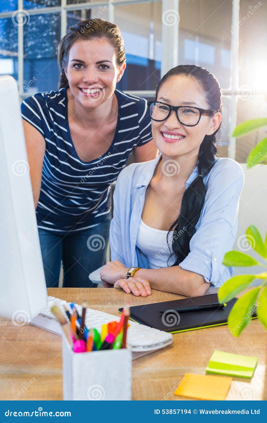 Smiling Partners Working Together on Computer Stock Photo - Image of ...