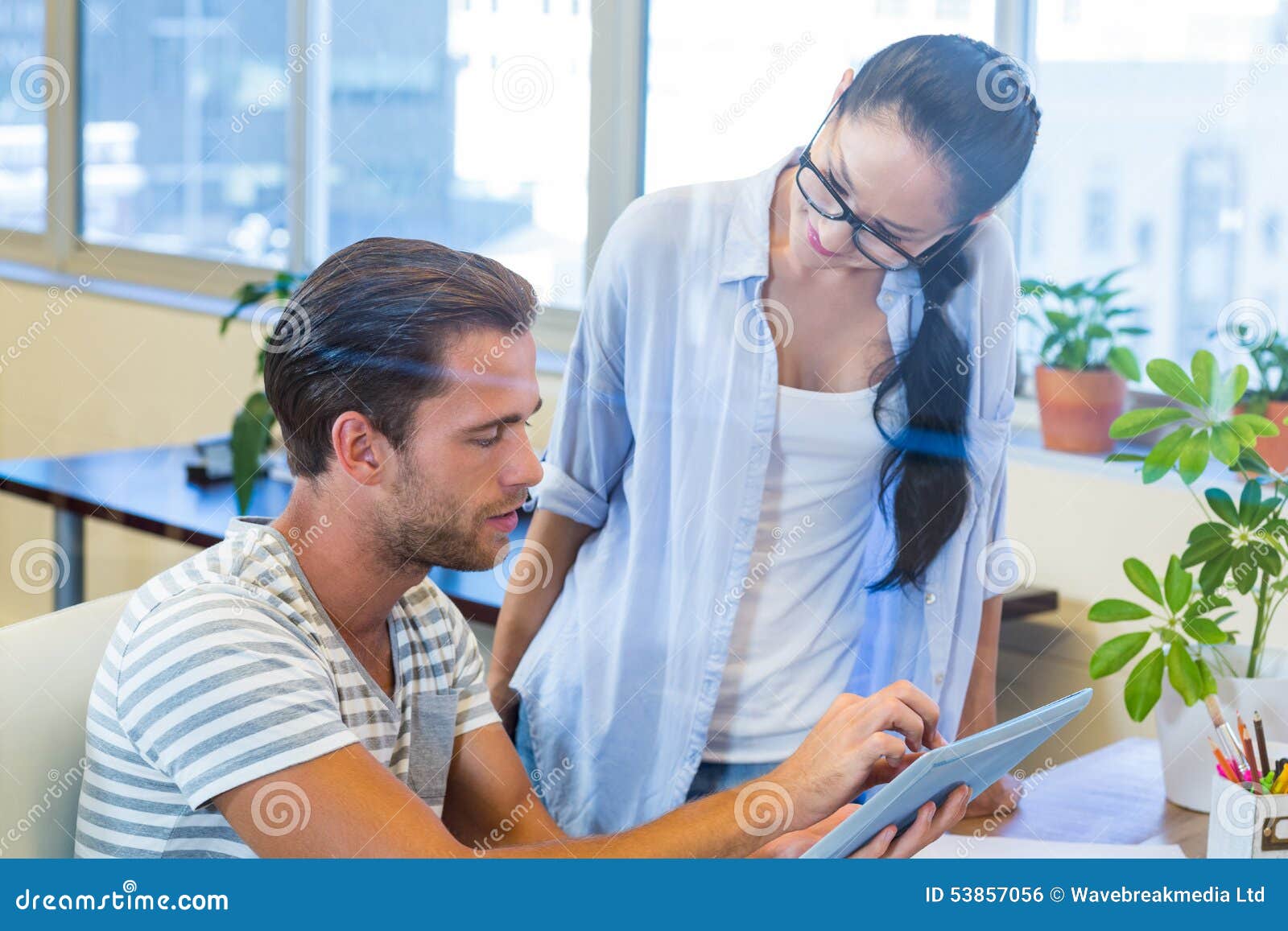 Smiling Partners Working Together on Tablet Stock Photo - Image of ...