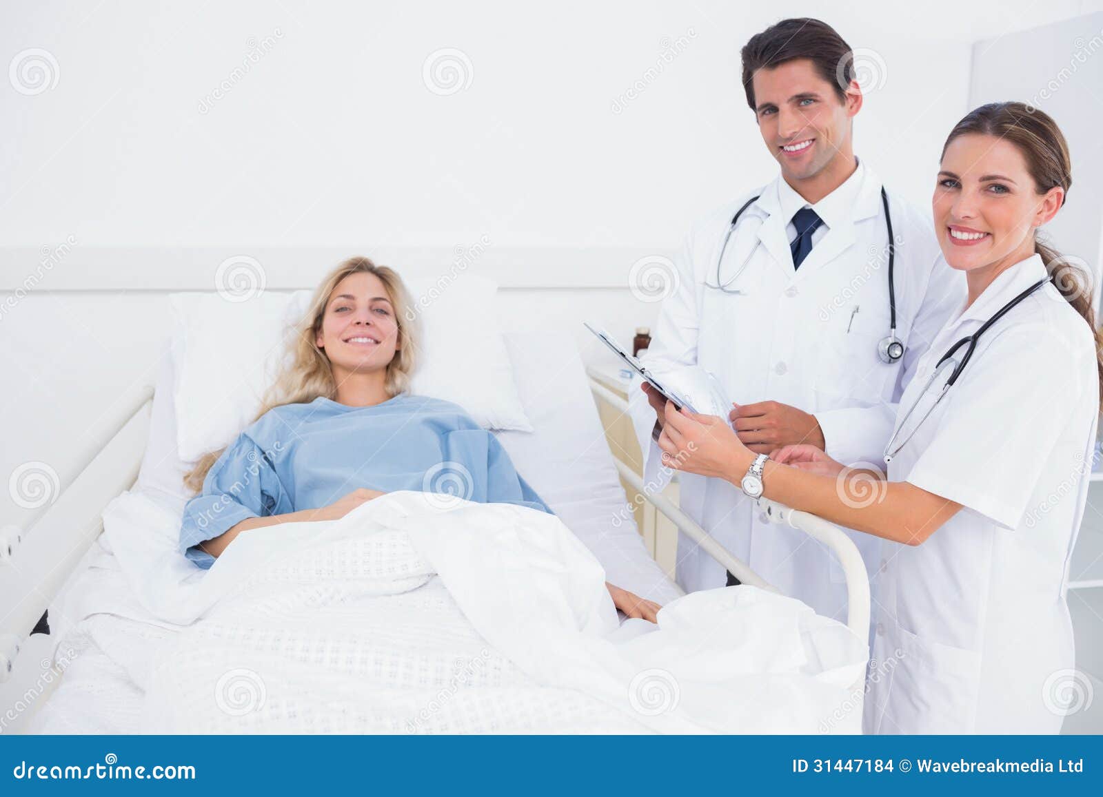 Smiling Patient and Doctors Stock Photo - Image of holding, happy: 31447184