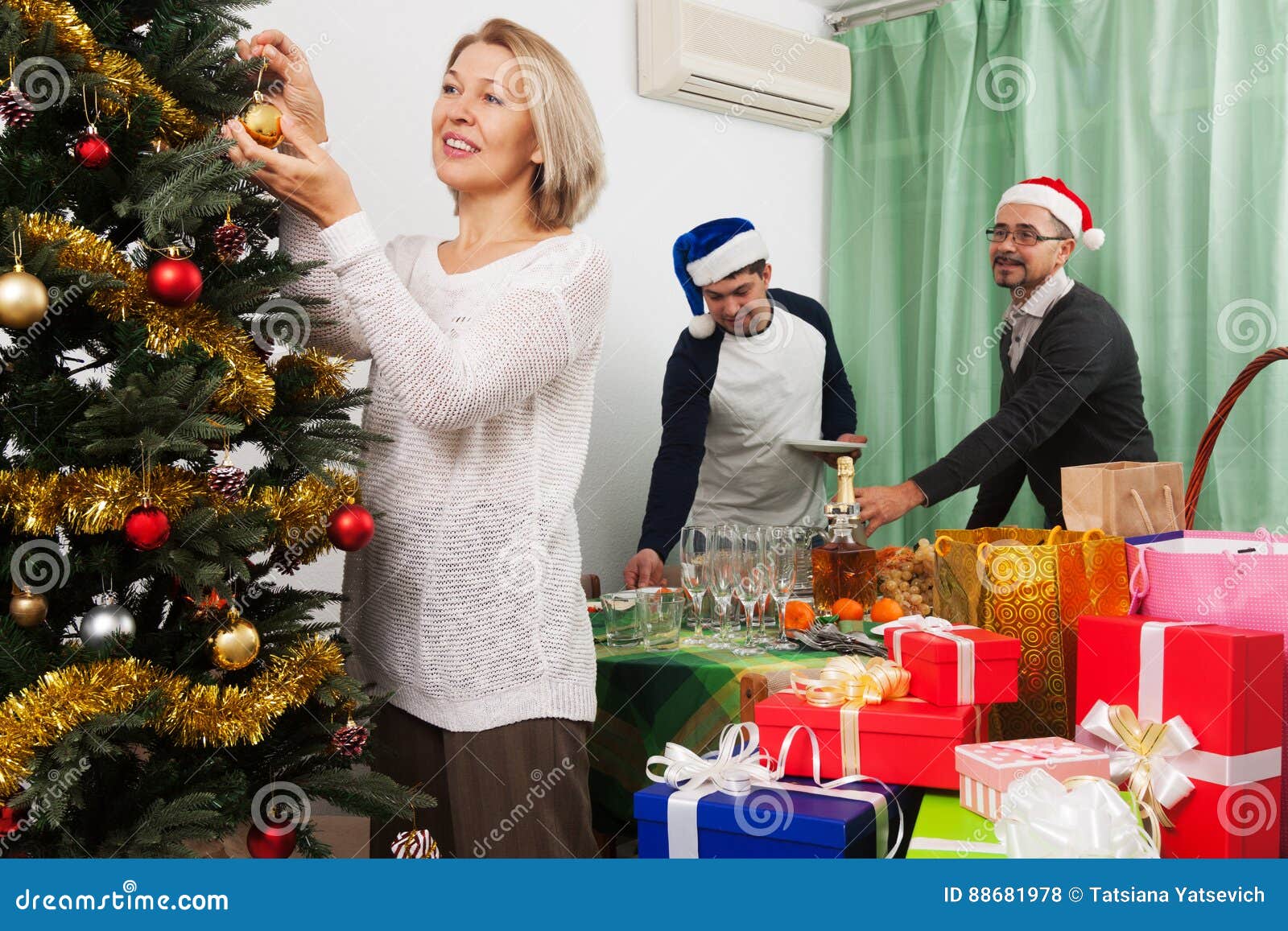Smiling People Decorate Christmas Tree Stock Photo - Image of portrait ...