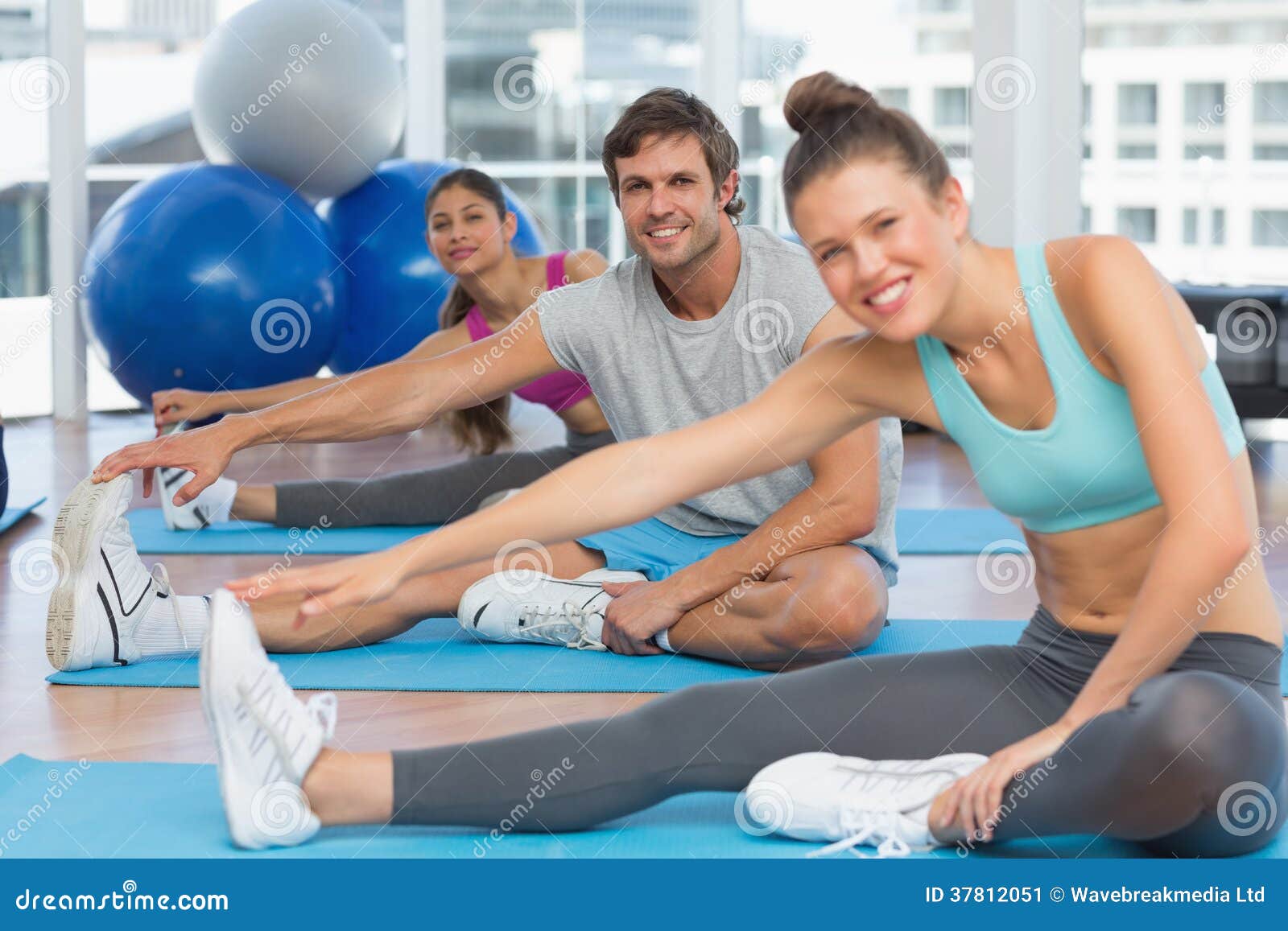 Smiling People Doing Stretching Exercises Stock Image - Image of ...