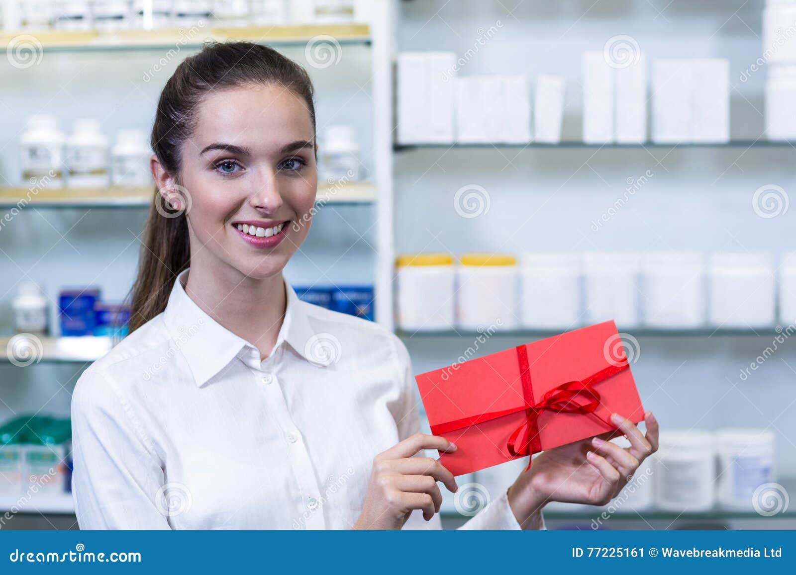 Smiling Pharmacist Holding Present in Pharmacy Stock Image - Image of ...