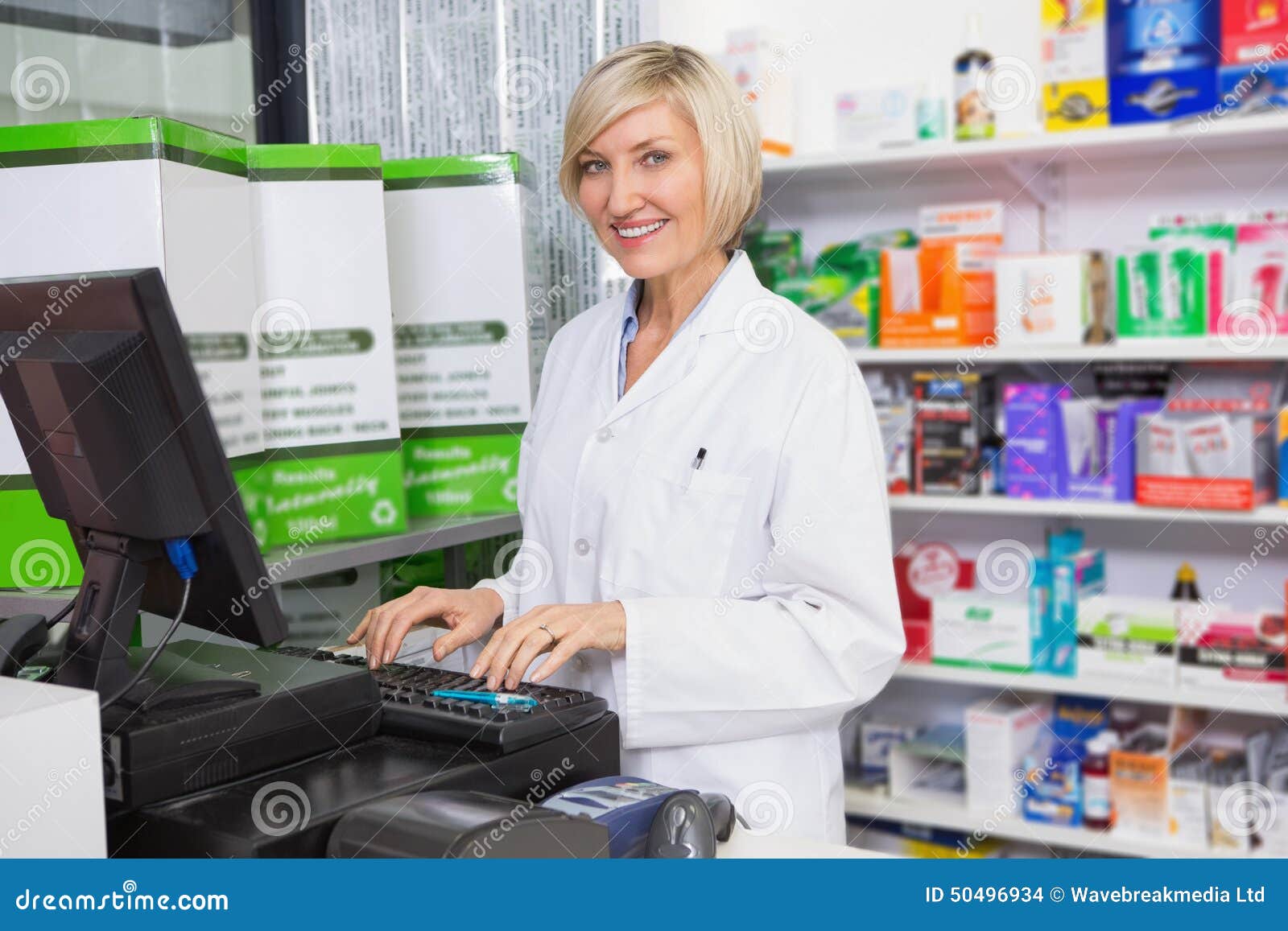 Smiling Pharmacist Using Computer Stock Photo - Image of medicament ...