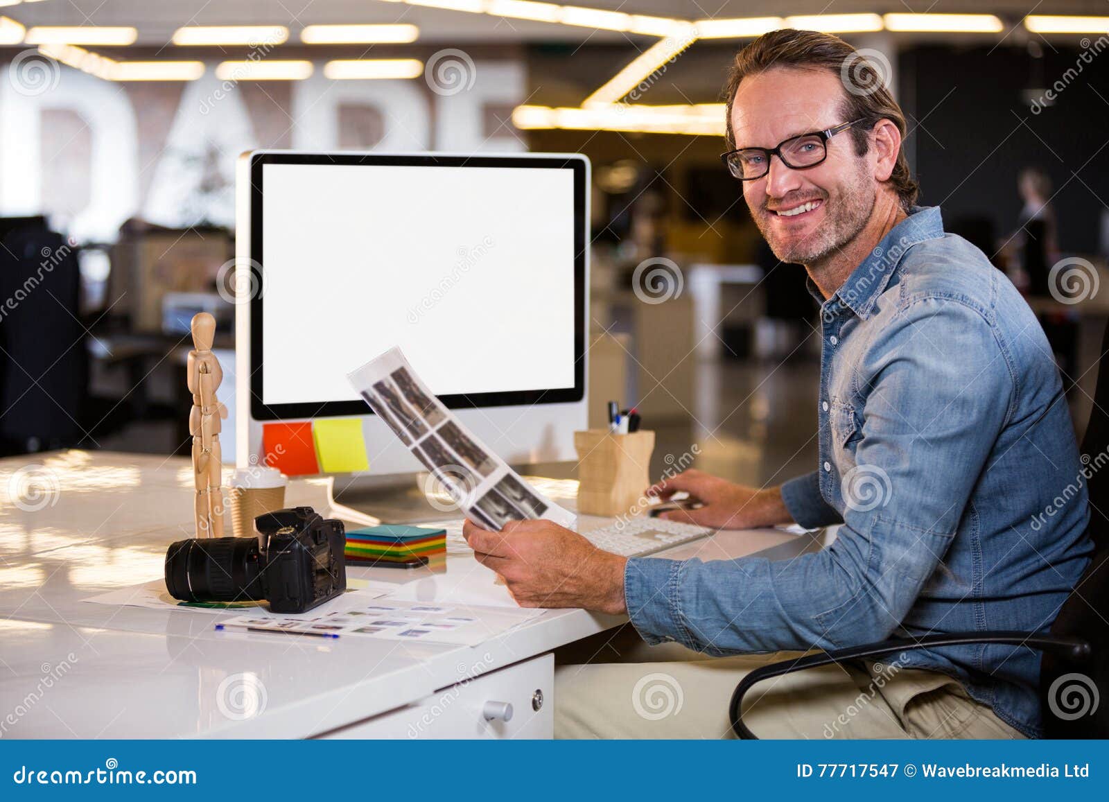 Smiling Photo Editor Sitting at Computer Desk Stock Image - Image of ...
