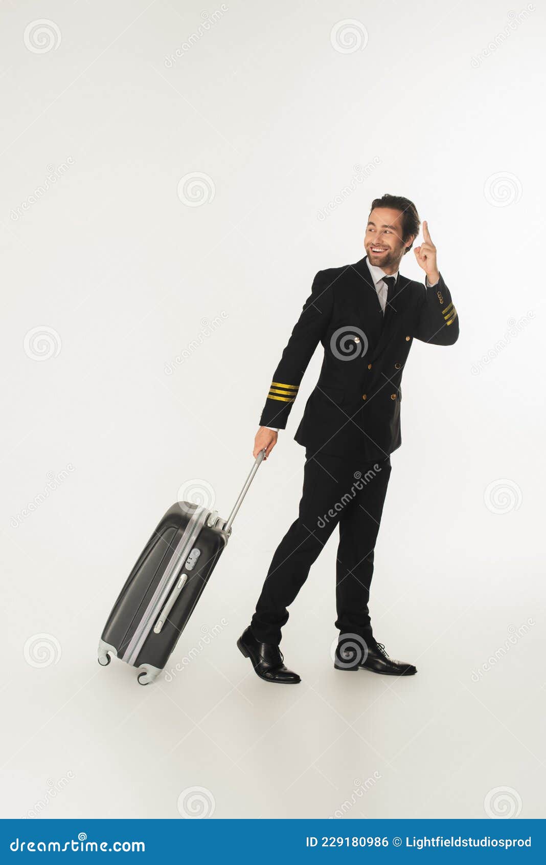 Smiling Pilot with Suitcase Pointing with Stock Photo - Image of ...