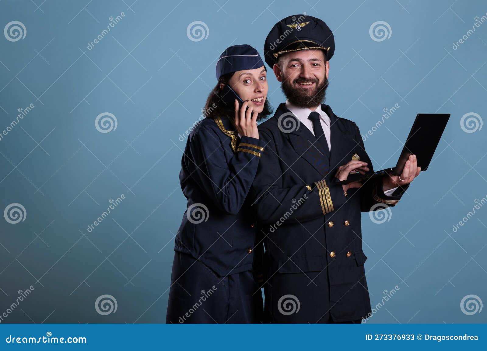 Smiling Pilot Using Laptop, Flight Attendant Talking on Smartphone ...