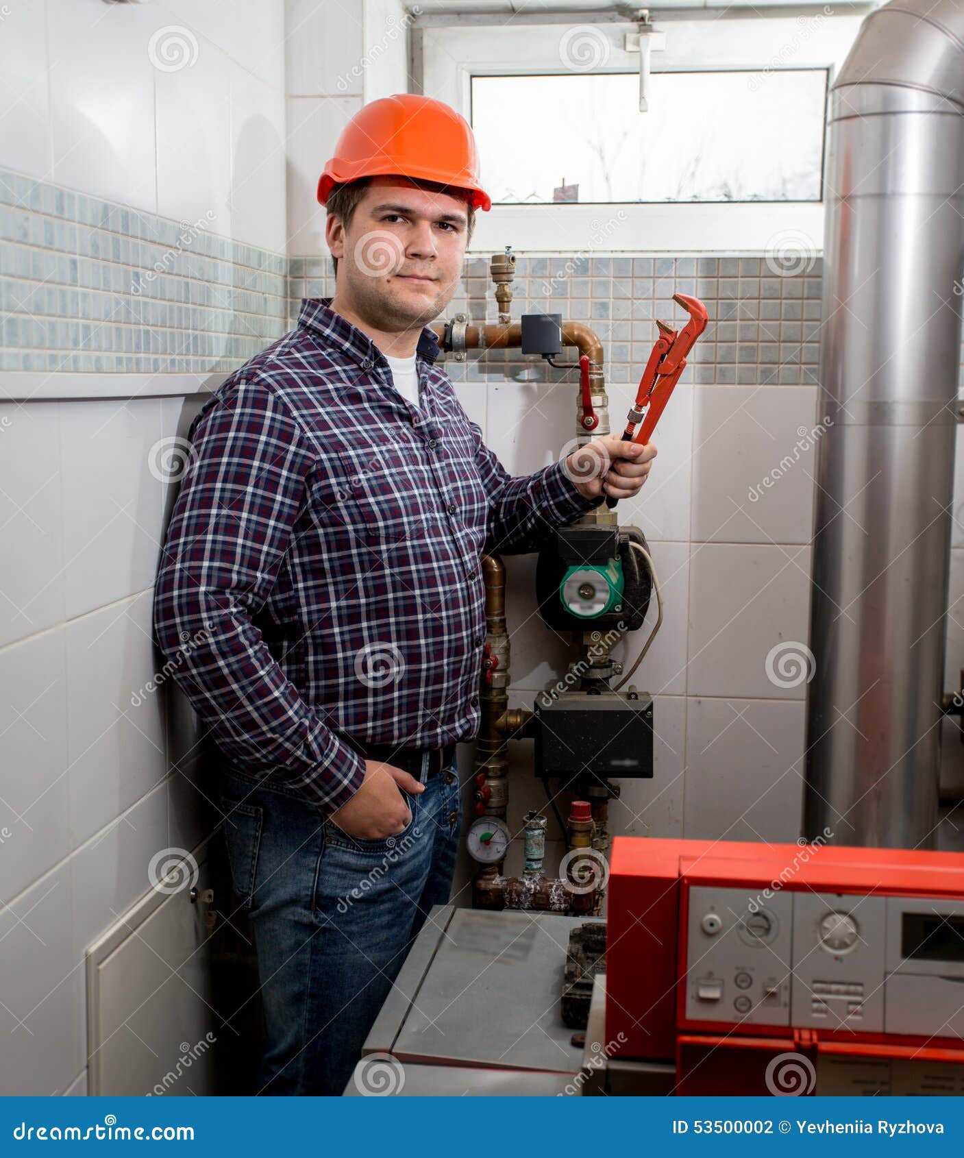 Smiling Plumber Posing with Pliers at Boiler Room Stock Photo - Image ...