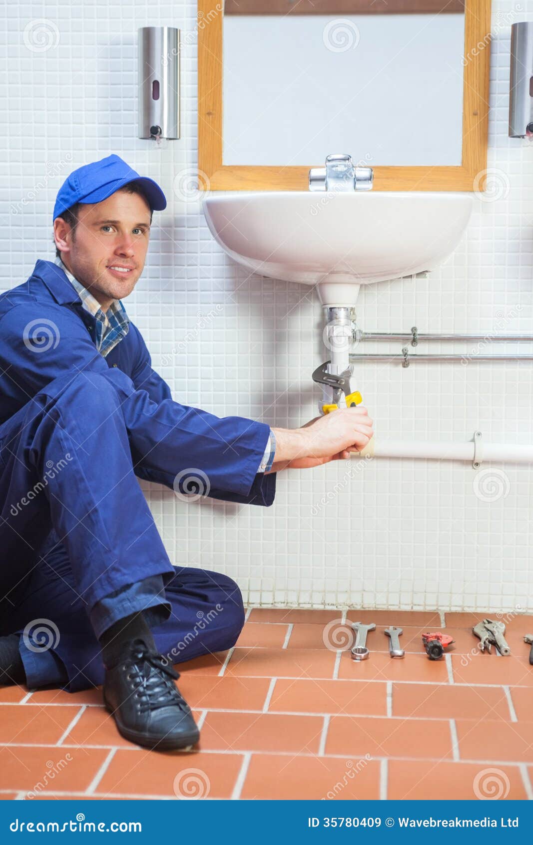 Smiling Plumber Repairing Sink Stock Image - Image of plumbing, looking ...