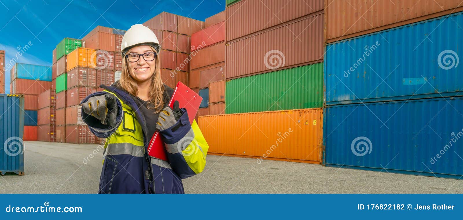 Smiling Port Worker Points Her Finger at the Viewer in the Background ...