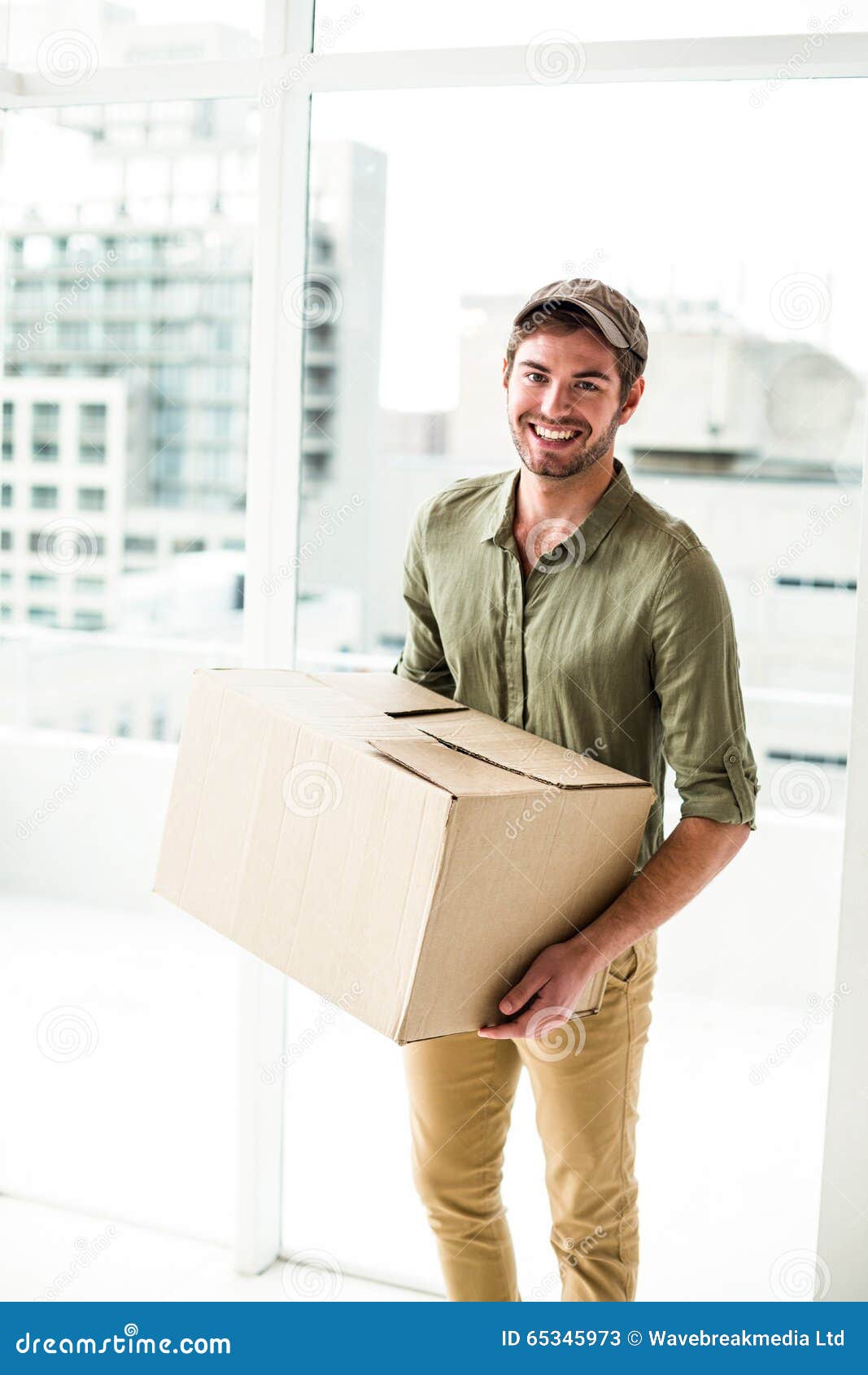 Smiling Postman Holding Package Stock Image - Image of cardboard ...