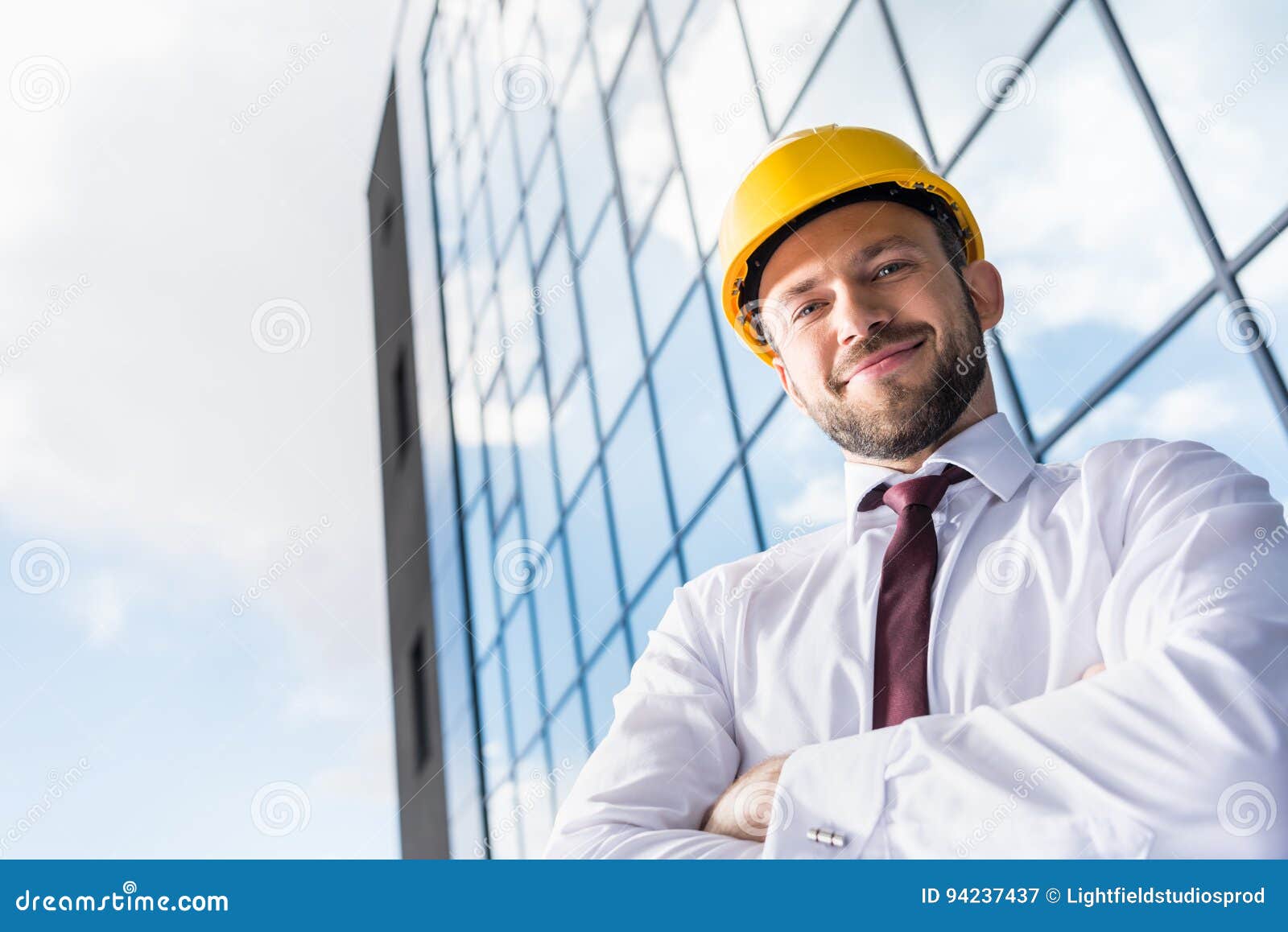 Smiling Professional Architect in Hard Hat Against Building Stock Image ...