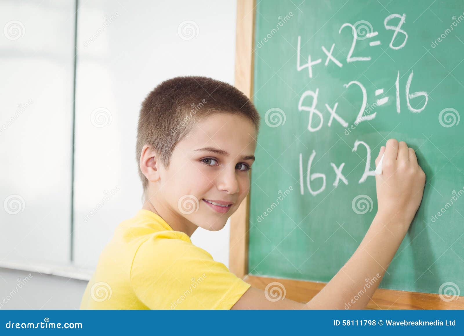 Smiling Pupil Calculating on Chalkboard in a Classroom Stock Photo ...