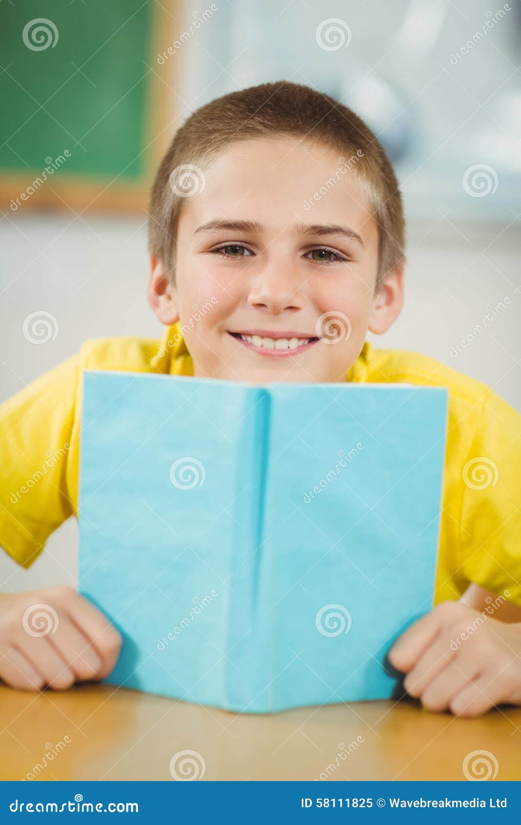 Smiling Pupil Reading Book in a Classroom Stock Image - Image of ...