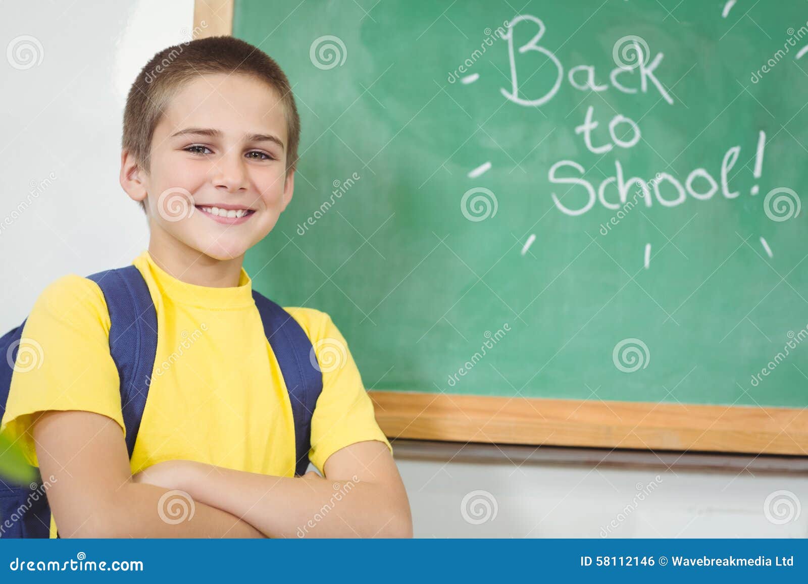 Smiling Pupil Standing in Front of Chalkboard Stock Photo - Image of ...