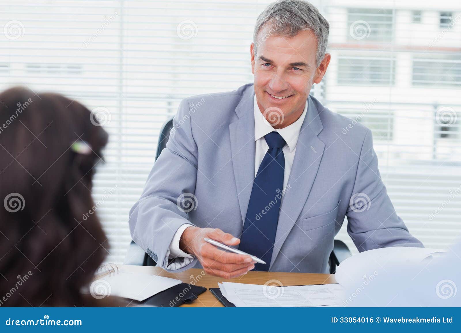 Smiling Real Estate Agent Completing Contract with Couple Stock Photo ...