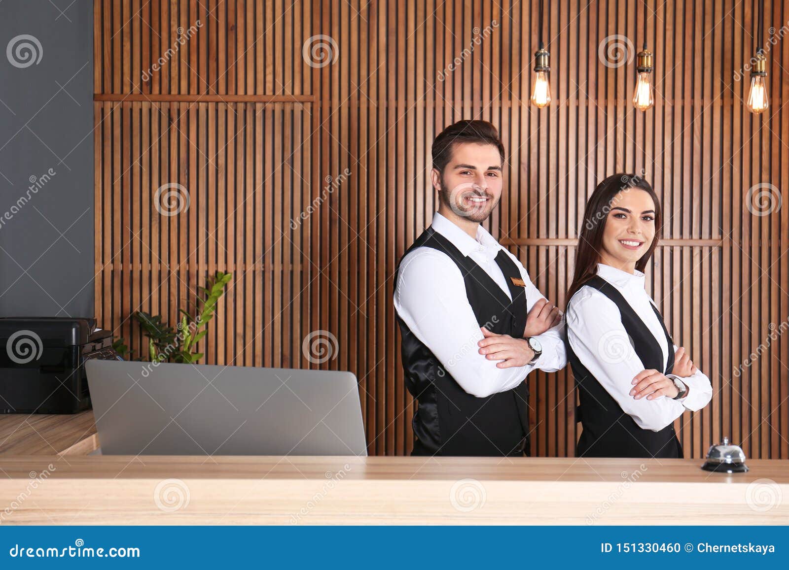 Smiling Receptionists at Desk Stock Photo - Image of computer, hotel ...