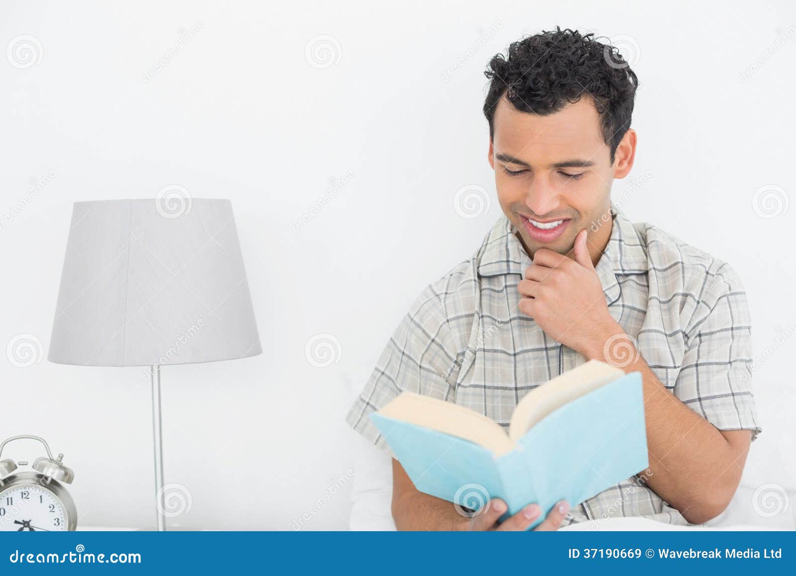 Smiling Relaxed Man Reading Book in Bed Stock Image - Image of home ...