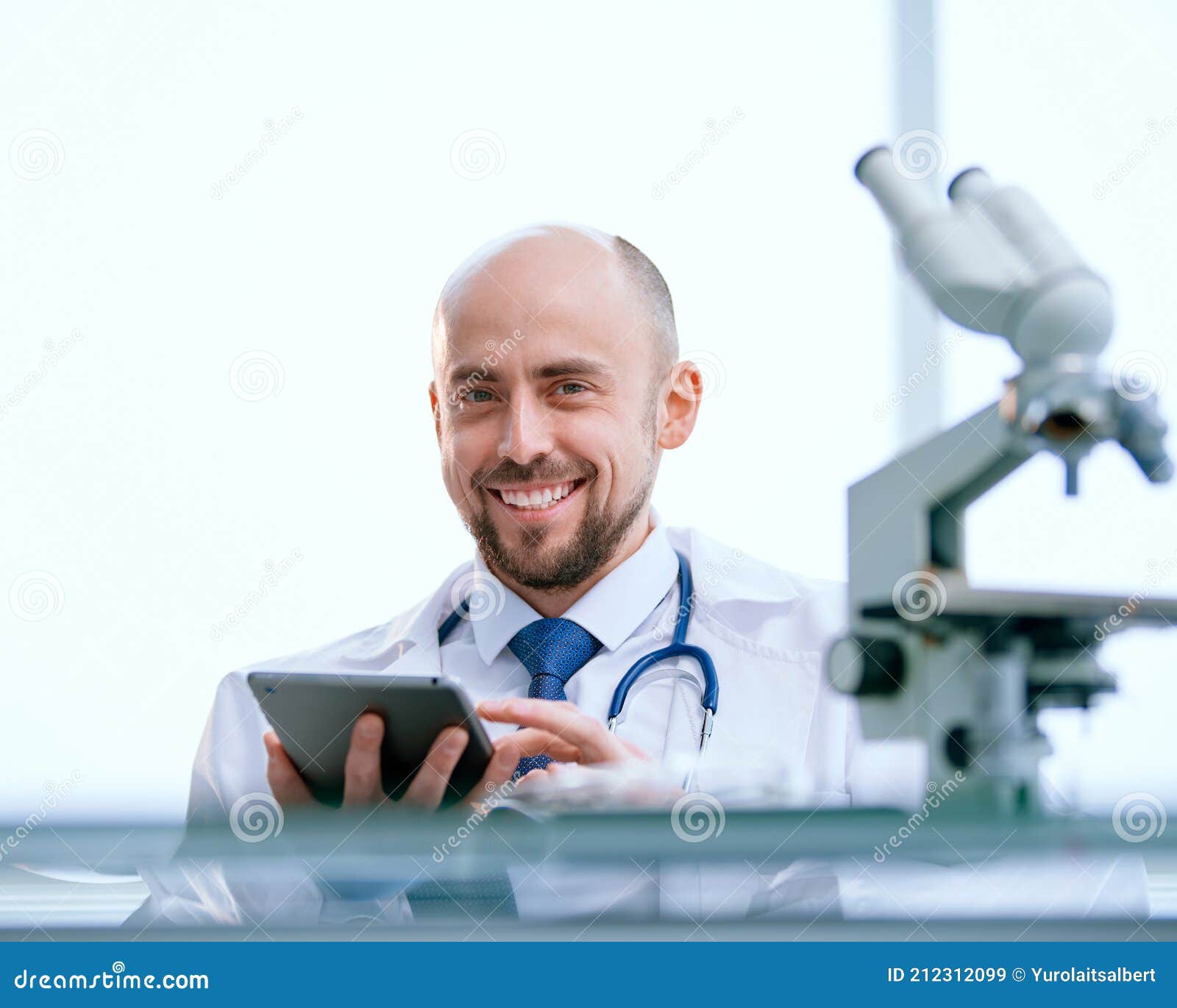 Smiling Researcher with a Digital Tablet Sitting in Front of a ...