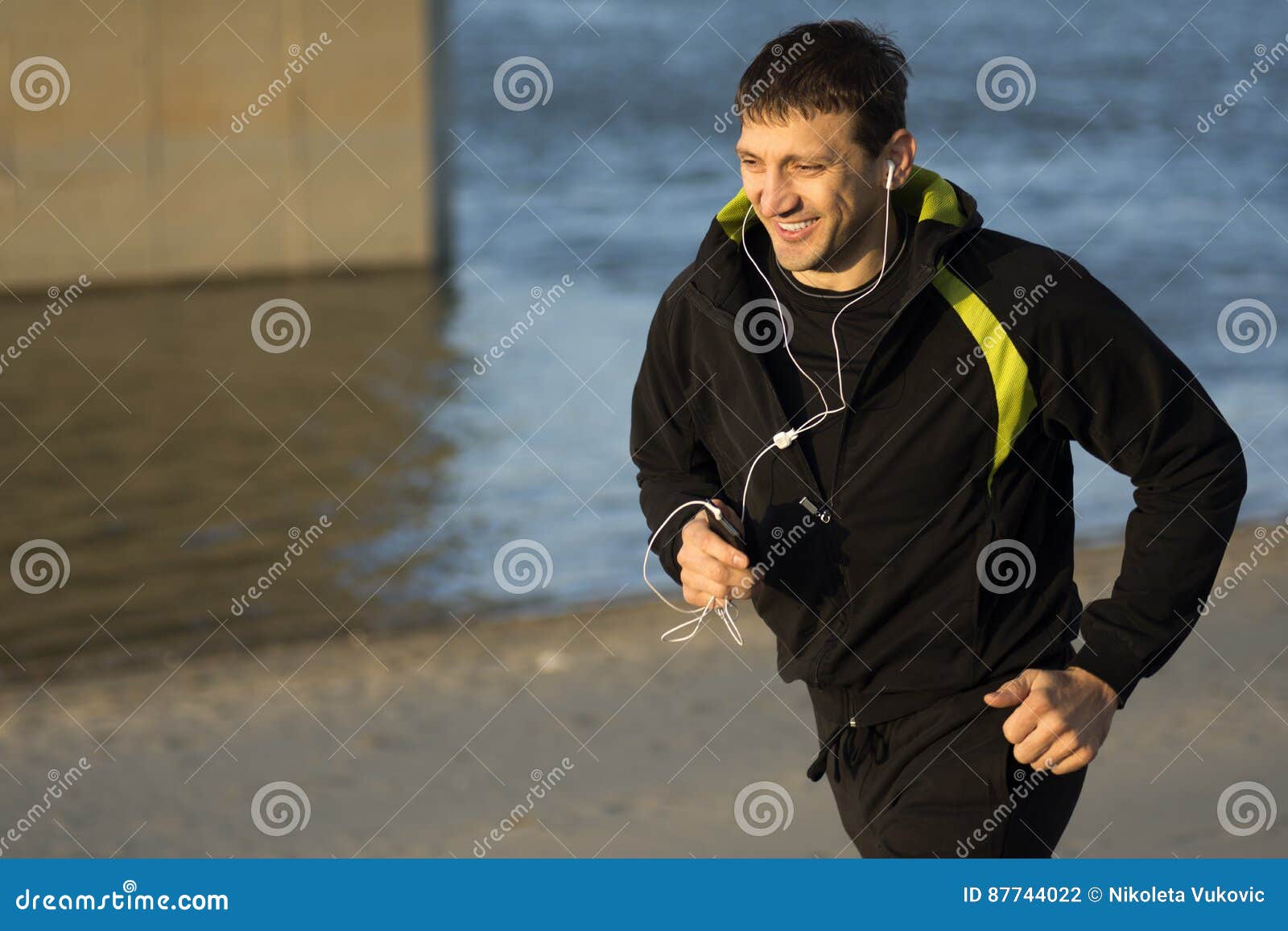Smiling Runner with Earphones Stock Photo - Image of black, smile: 87744022