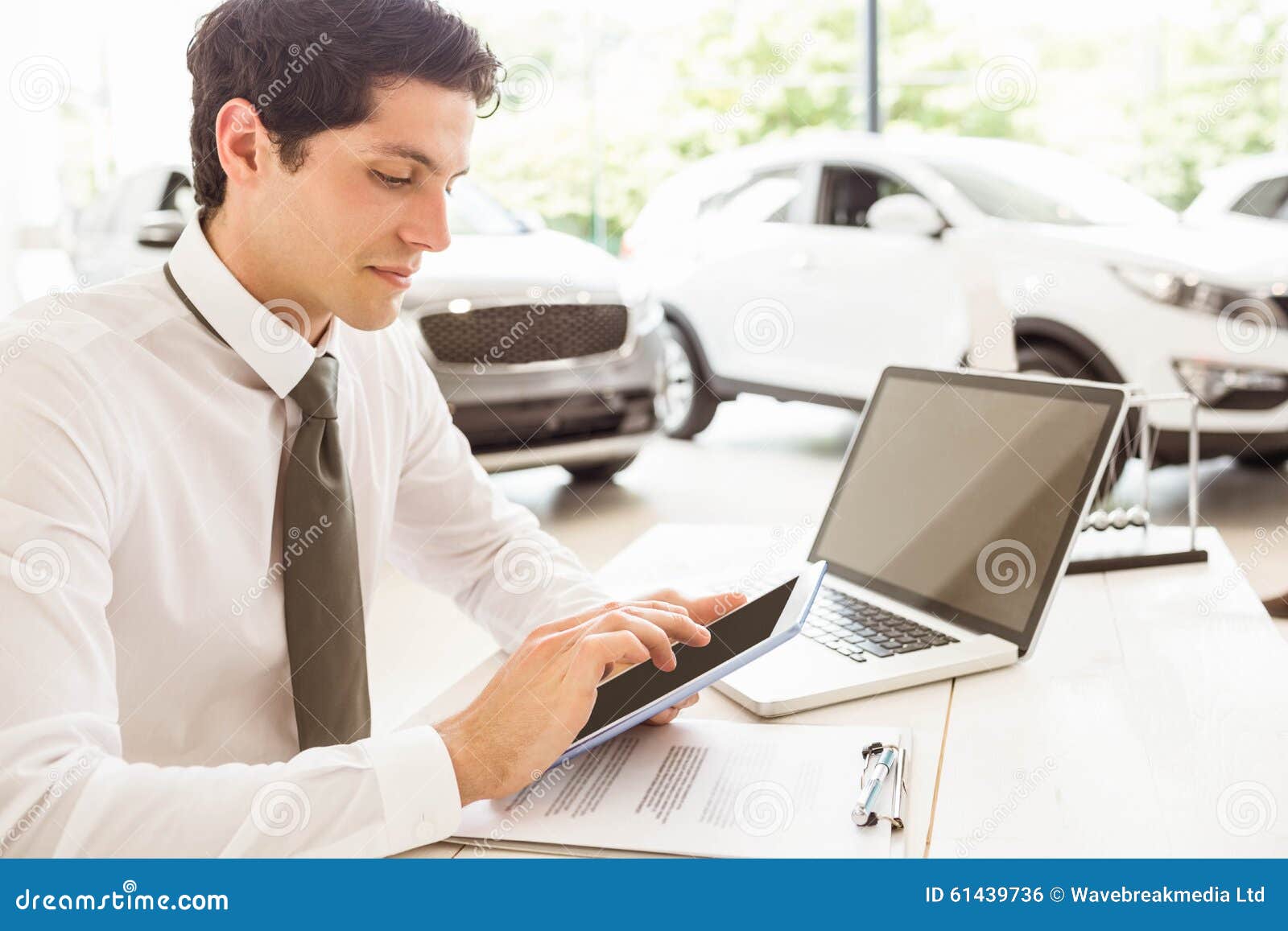 Smiling Salesman Using Tablet at His Desk Stock Photo - Image of ... Smiling Salesman Using Tablet at His Desk Stock Photo - Image of ...
