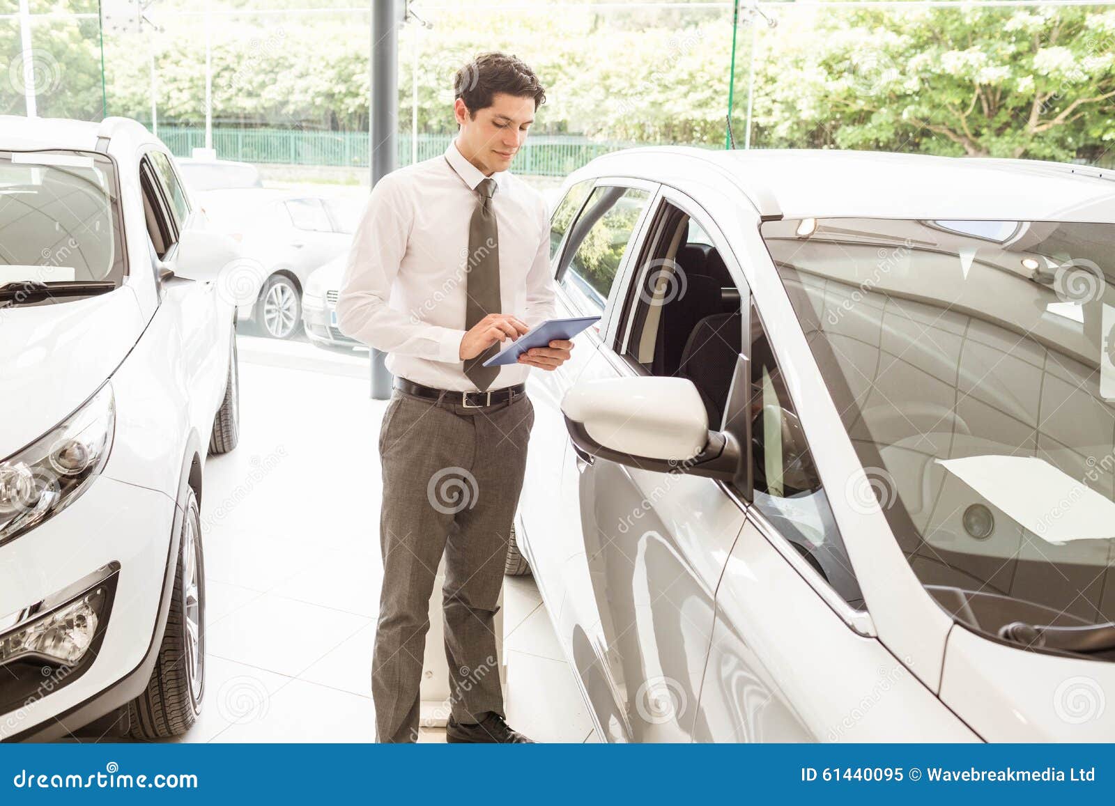 Smiling Salesman Using Tablet Near a Car Stock Image - Image of ... Smiling Salesman Using Tablet Near a Car Stock Image - Image of ...