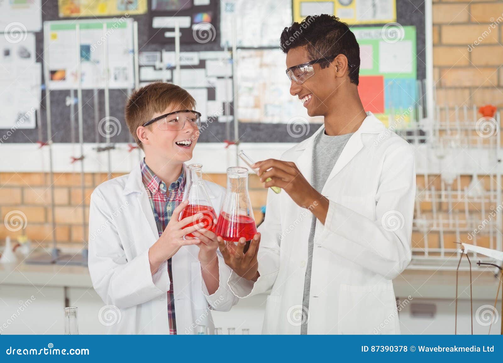 Smiling School Kids Doing a Chemical Experiment in Laboratory Stock ...