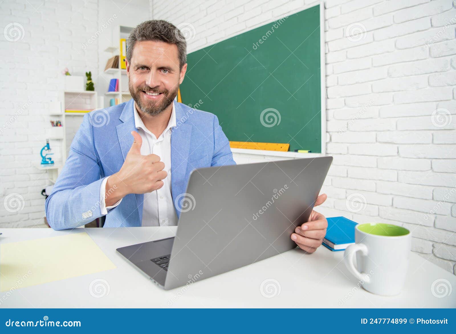 Smiling School Teacher in Classroom with Computer at Blackboard Stock ...