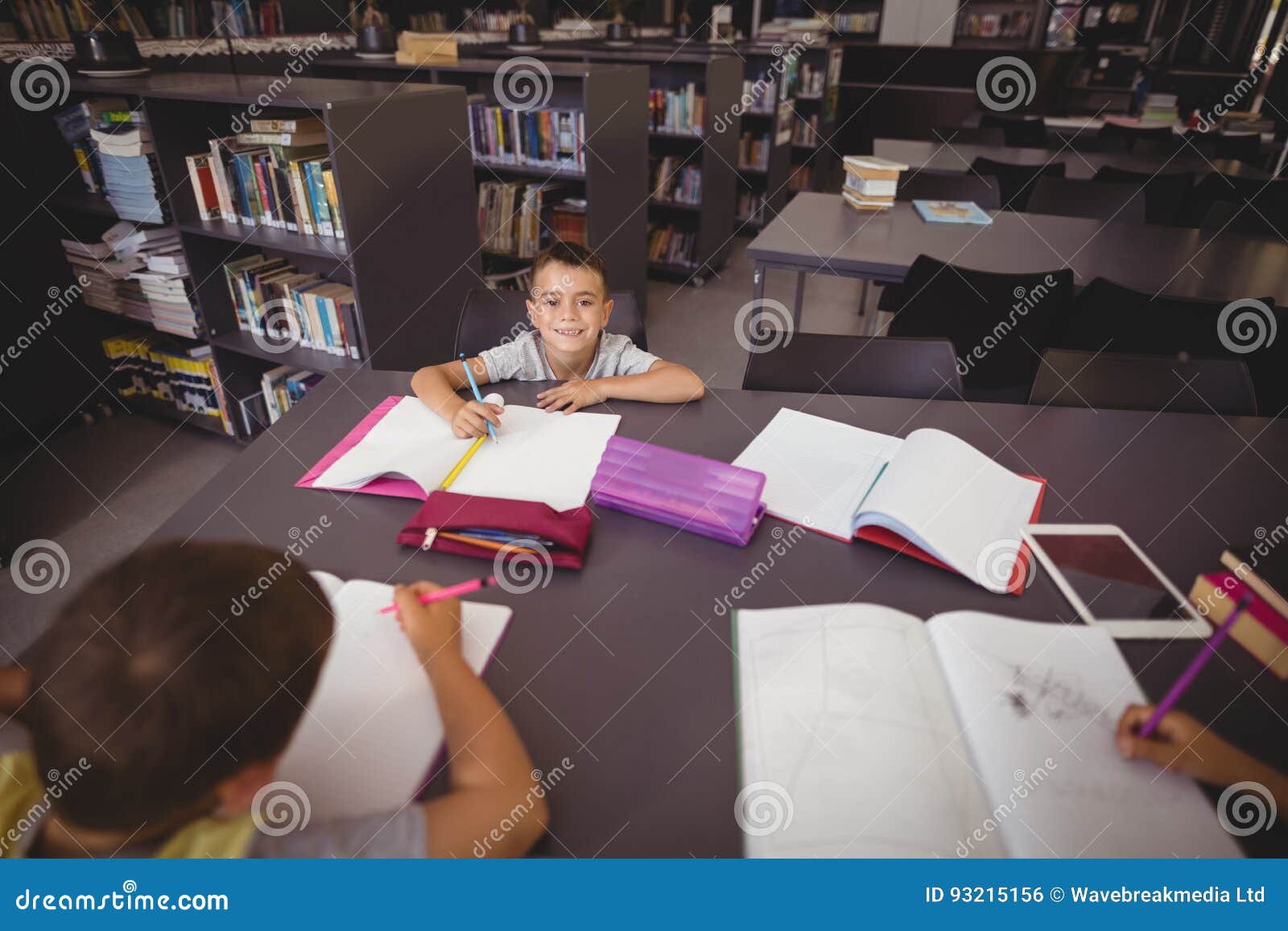 Smiling Schoolboy Doing His Homework in Library Stock Photo - Image of ...