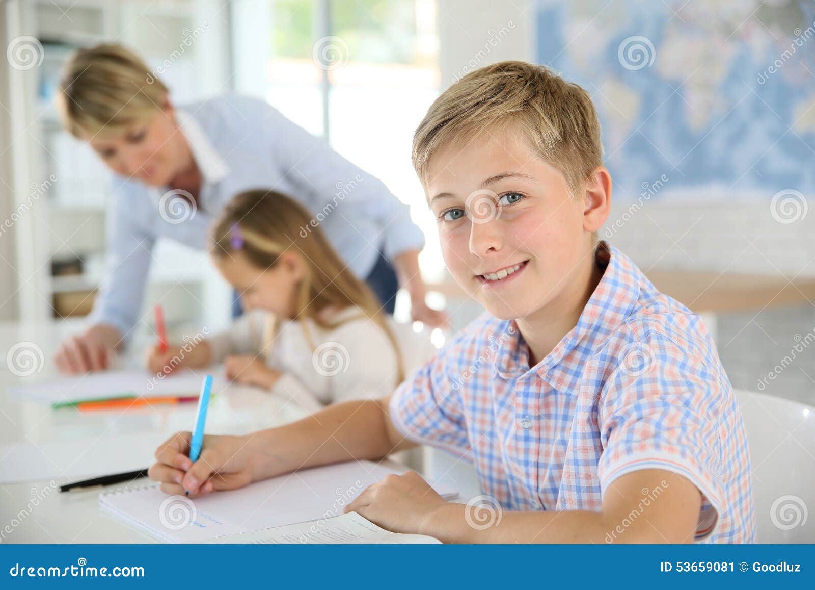 Smiling Schoolboy Writing in Class Stock Image - Image of girl, indoors ...