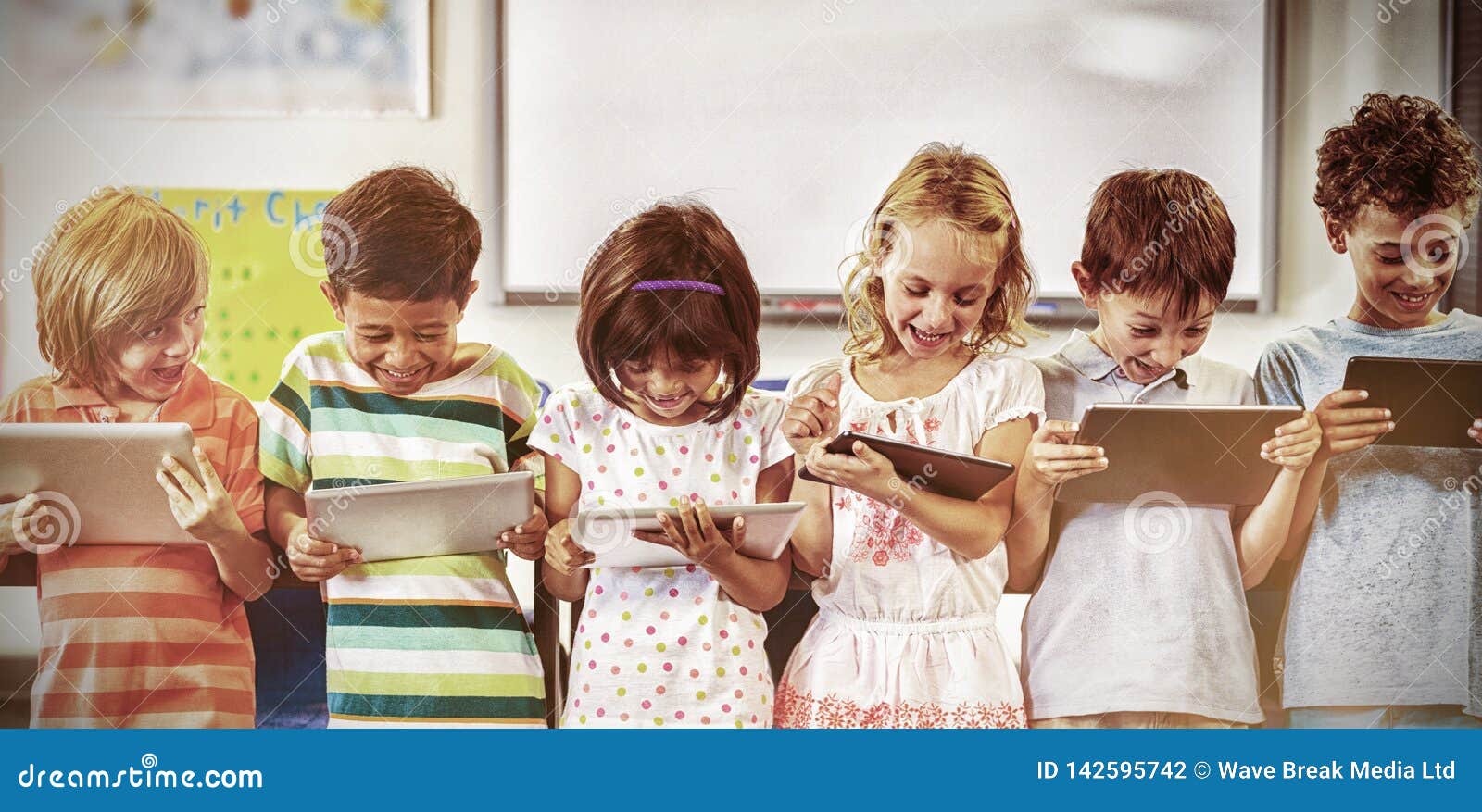 Smiling Schoolchildren Using Digital Tablets Stock Photo - Image of ...