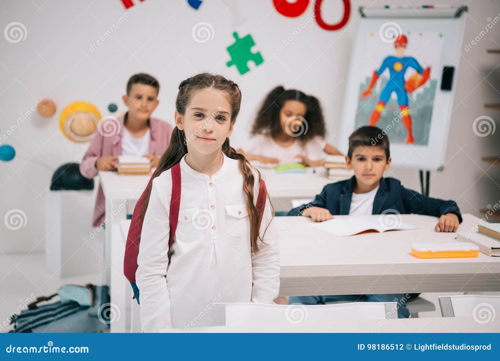 Smiling Schoolgirl with Multiethnic Classmates Looking at Camera in ...