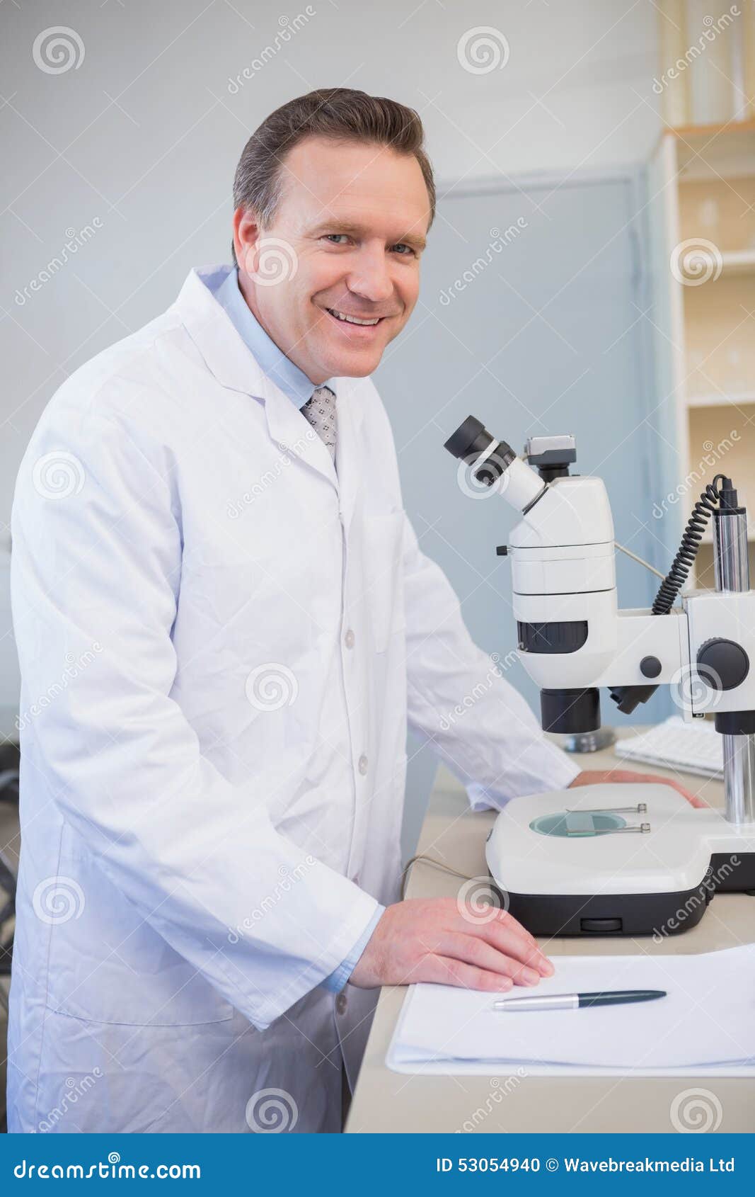 Smiling Scientist Examining Sample with Microscope Stock Photo - Image ...