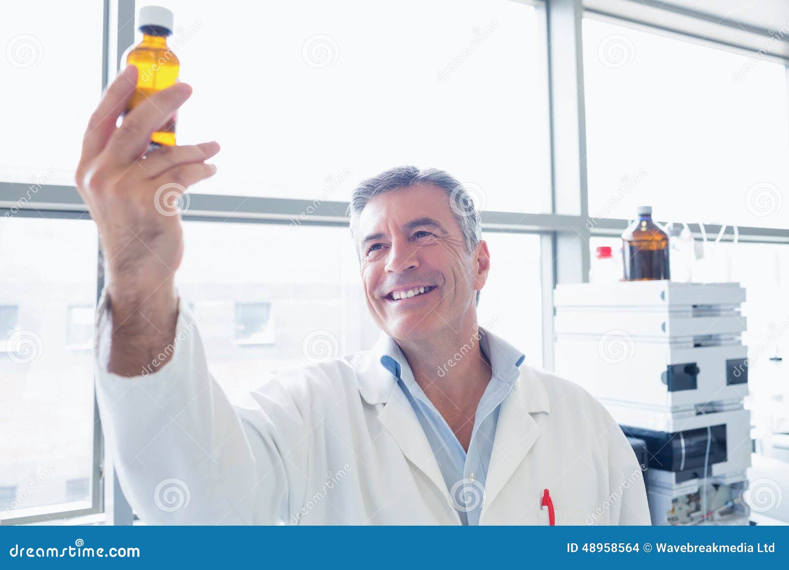 Smiling Scientist in Lab Coat Holding a Chemical Bottle Stock Photo ...