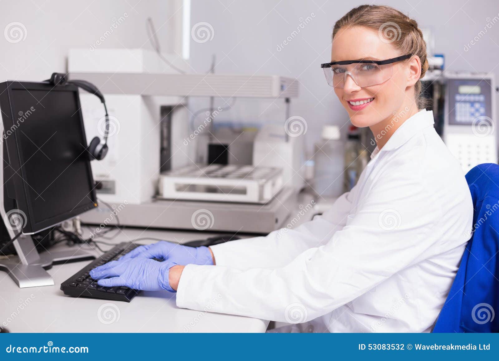 Smiling Scientist Looking at Camera and Using Computer Stock Photo ...