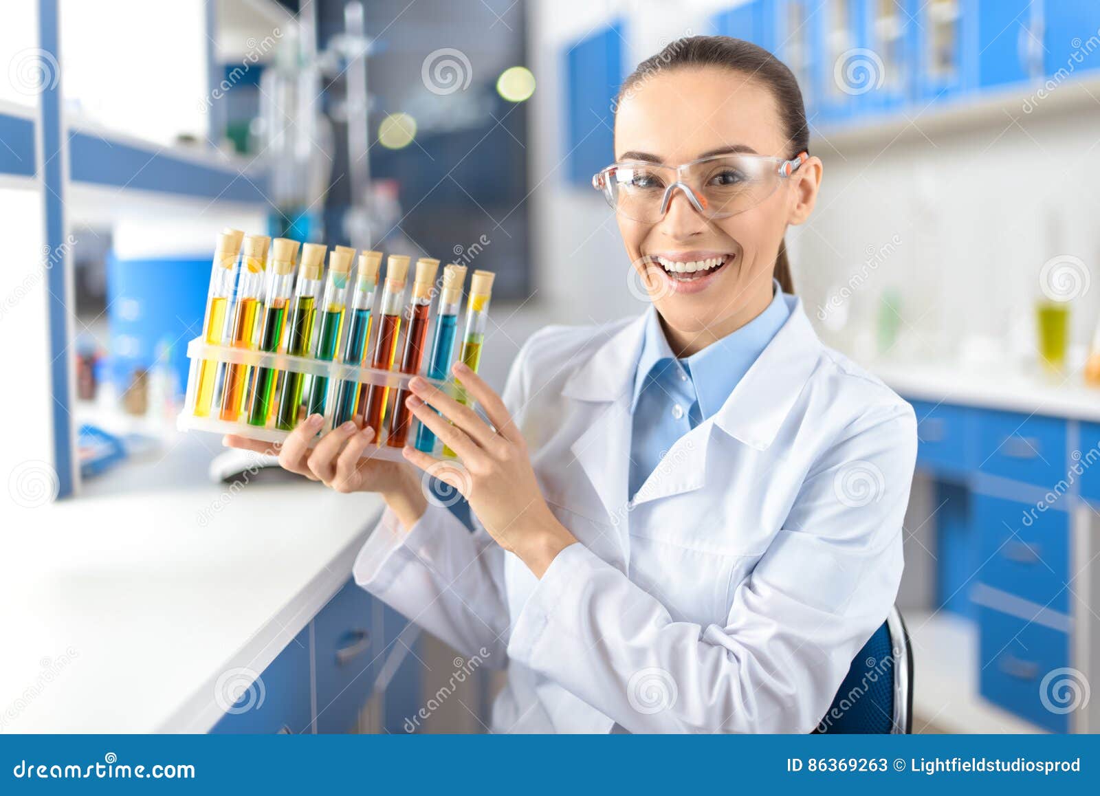 Smiling Scientist Showing Laboratory Tubes and Looking To Camera Stock ...
