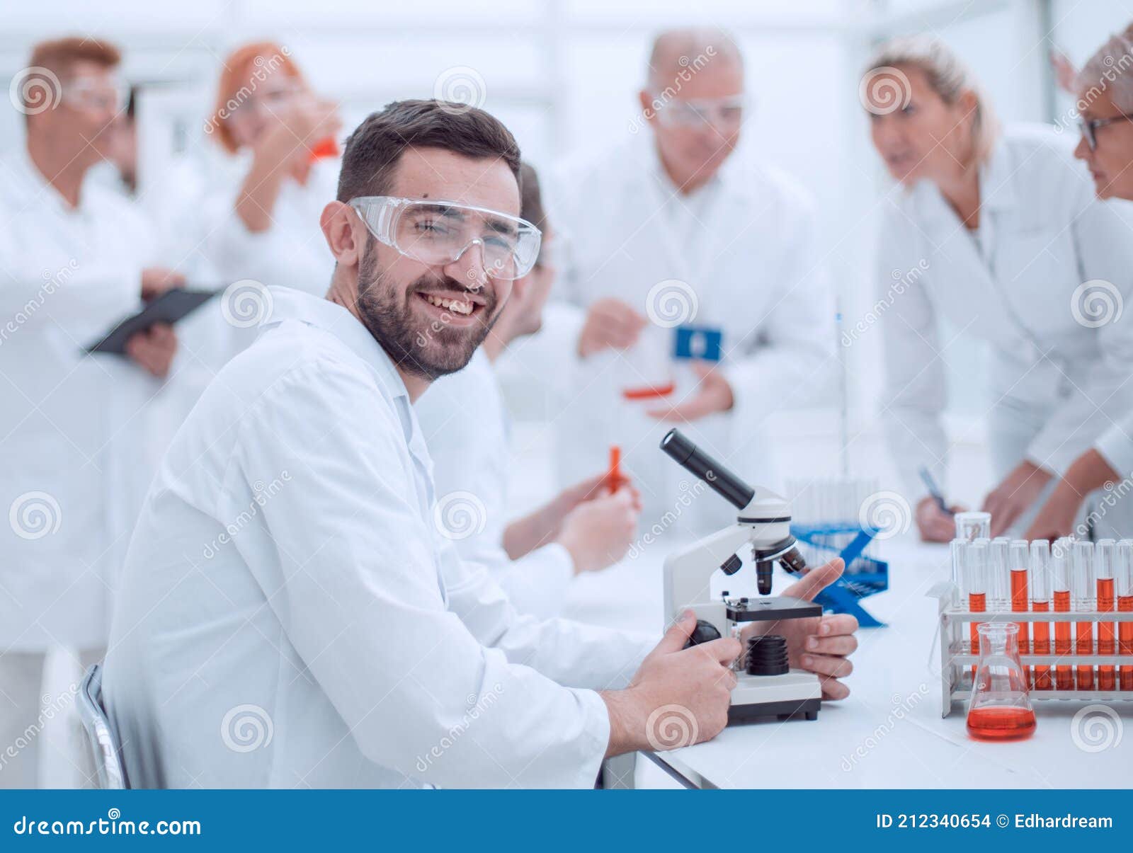 Smiling Scientist Sitting at a Laboratory Table . Stock Photo - Image ...
