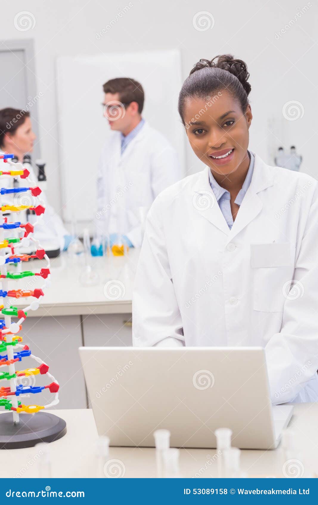 Smiling Scientist Using Laptop while Colleagues Talking Together Stock ...