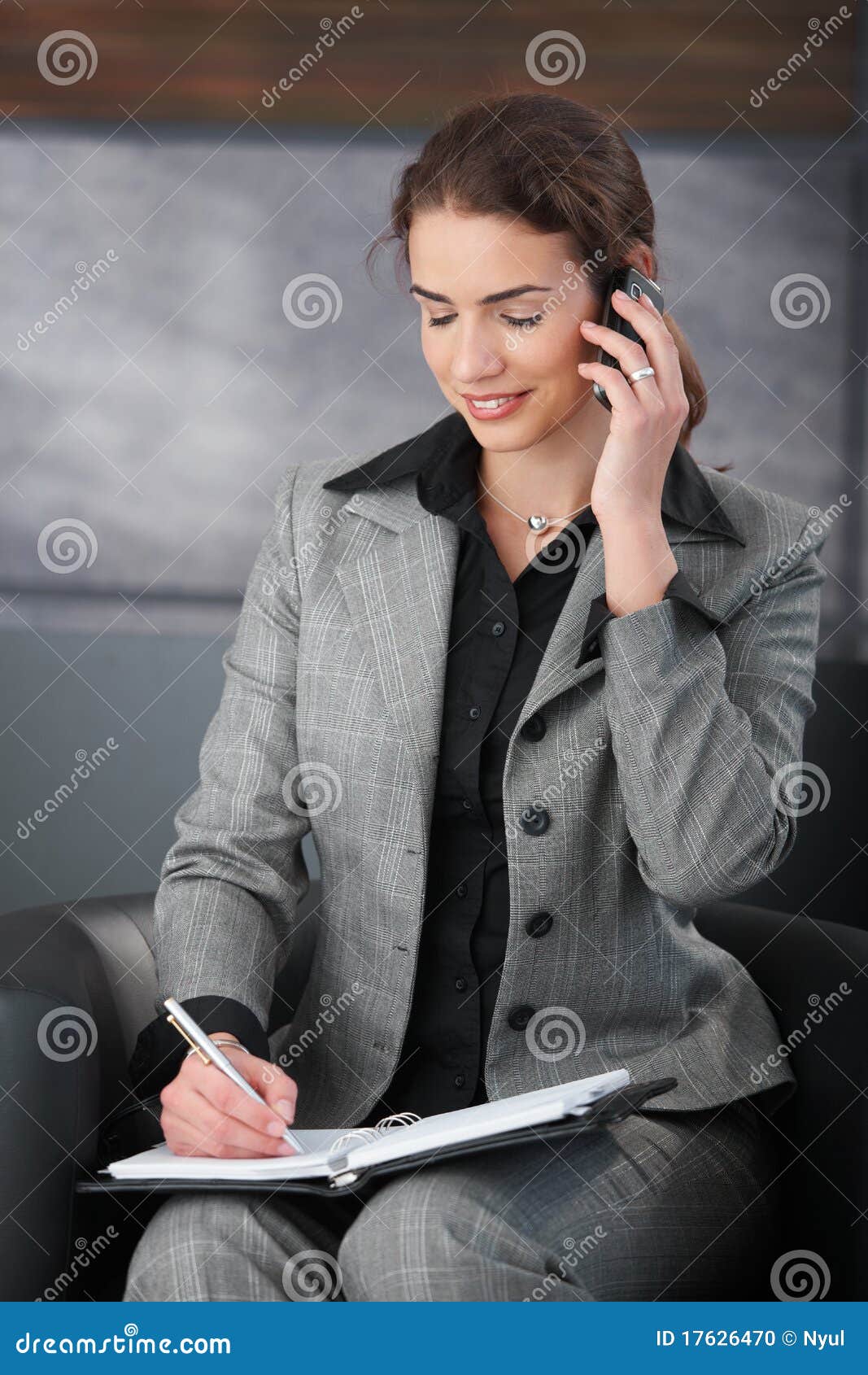 Smiling Secretary on Phone Writing Notes Stock Photo - Image of indoor ...