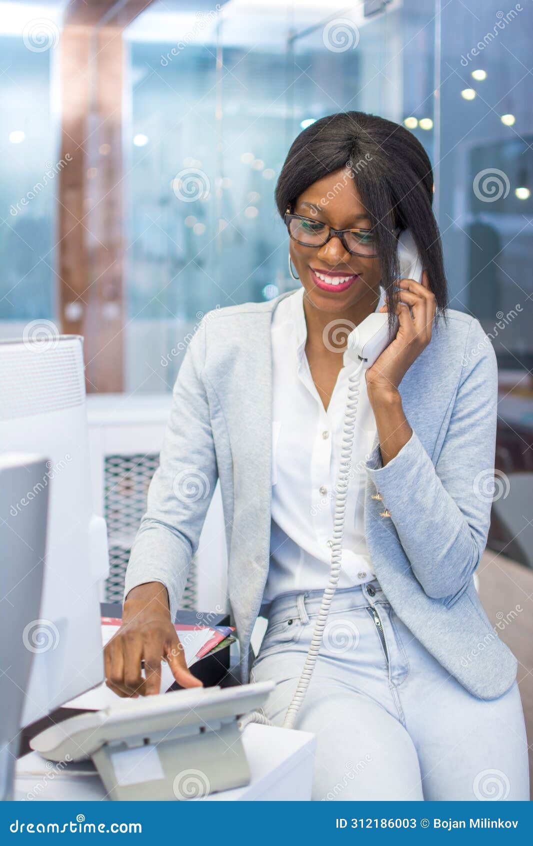 Smiling Secretary Talking on Phone in Modern Office Stock Image - Image ...